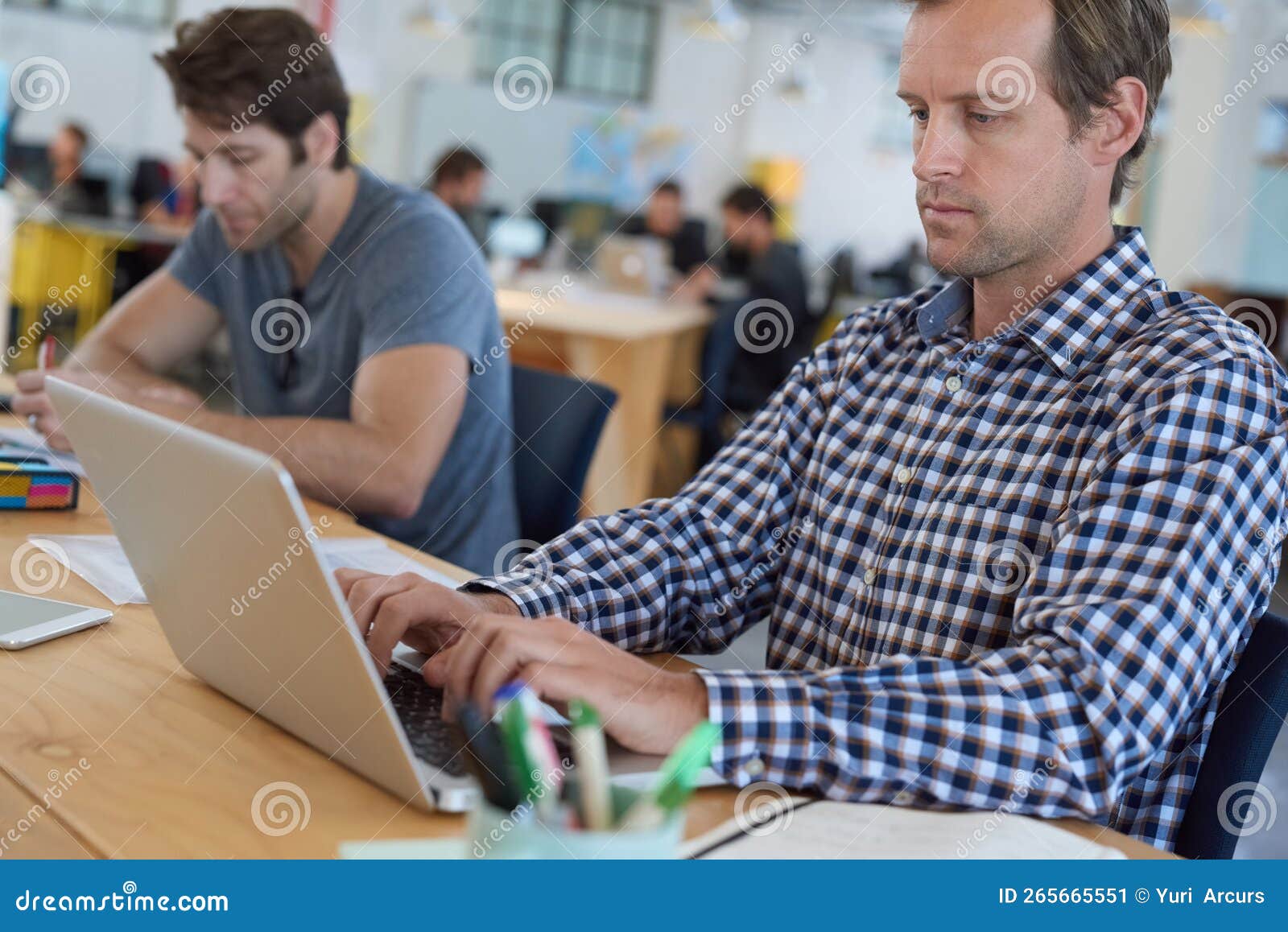 He Talks Code Fluently. Colleagues Working on Laptops at a Desk in a ...