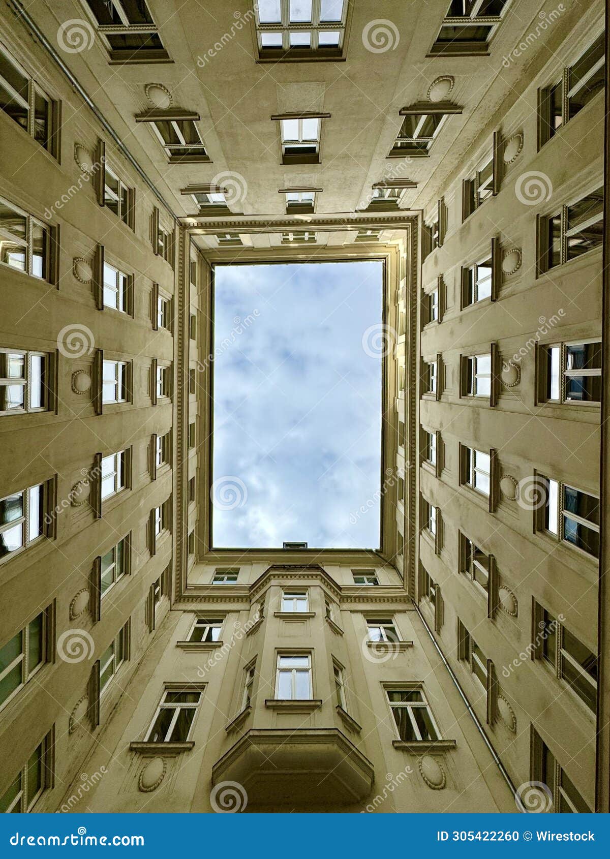 Tall Apartment Building with a Blue Sky Backdrop Stock Photo - Image of ...