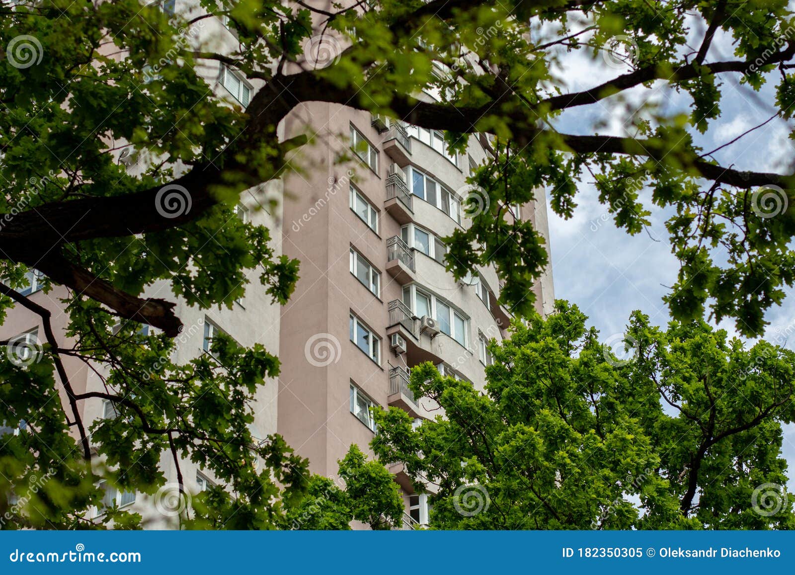 Tall Apartment Building among Trees and the Leaves Stock Image - Image ...