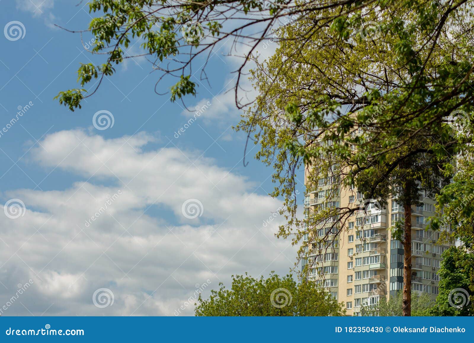 Tall Apartment Building among Trees and the Leaves Stock Photo - Image ...