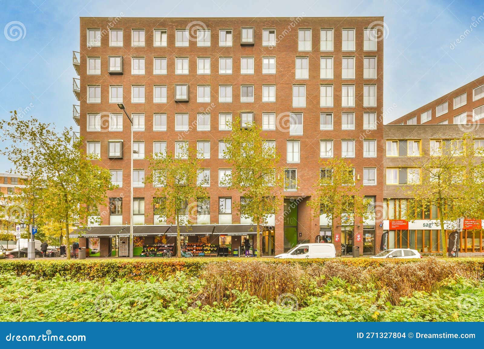 A Tall Brick Building with Trees in Front of it Editorial Stock Image ...