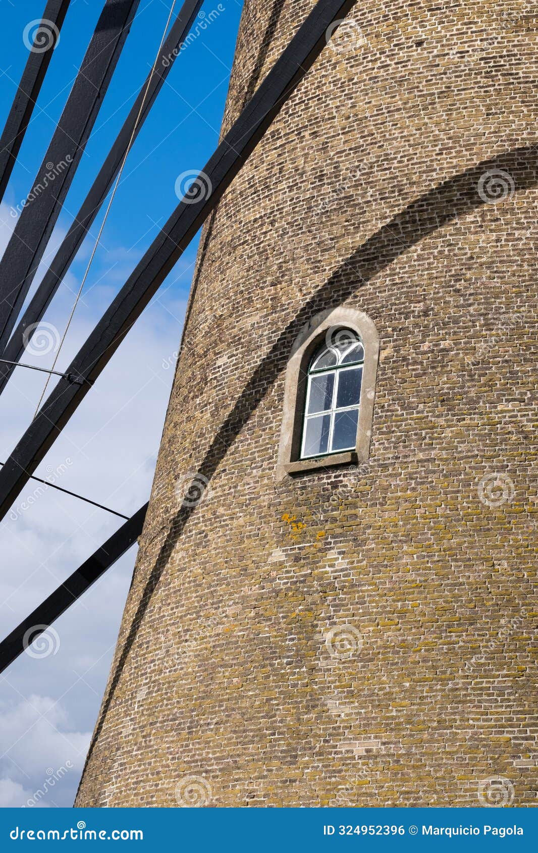 A Tall Brick Building with a Window on the Side Stock Photo - Image of ...