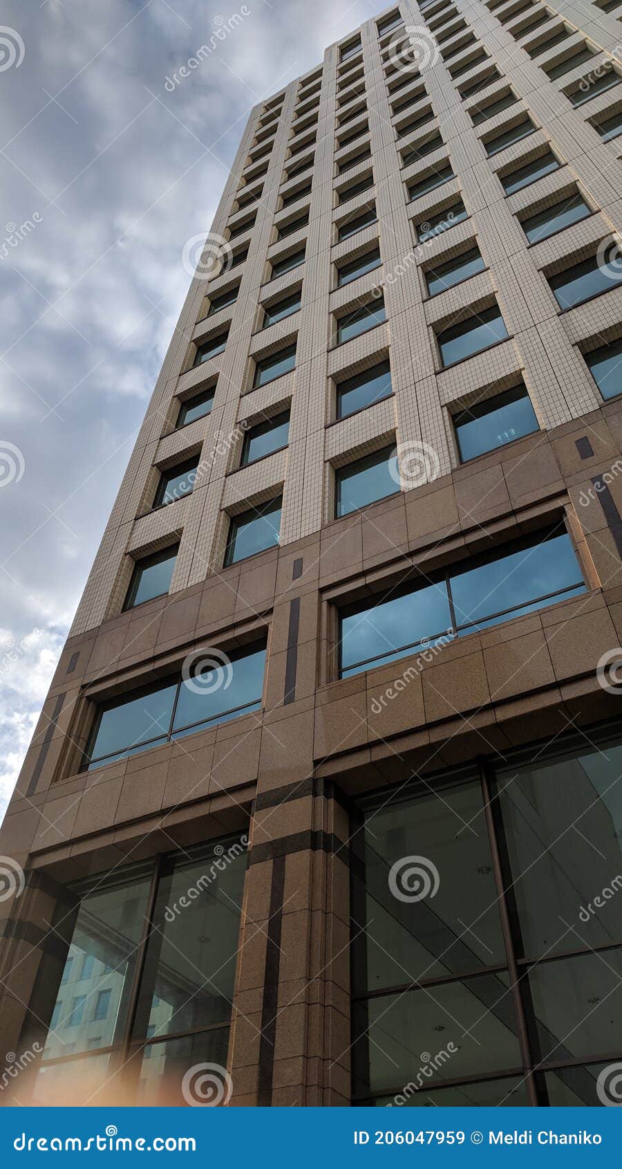 Tall Building from Below Viewpoint with Cloudy Sky Stock Image - Image ...