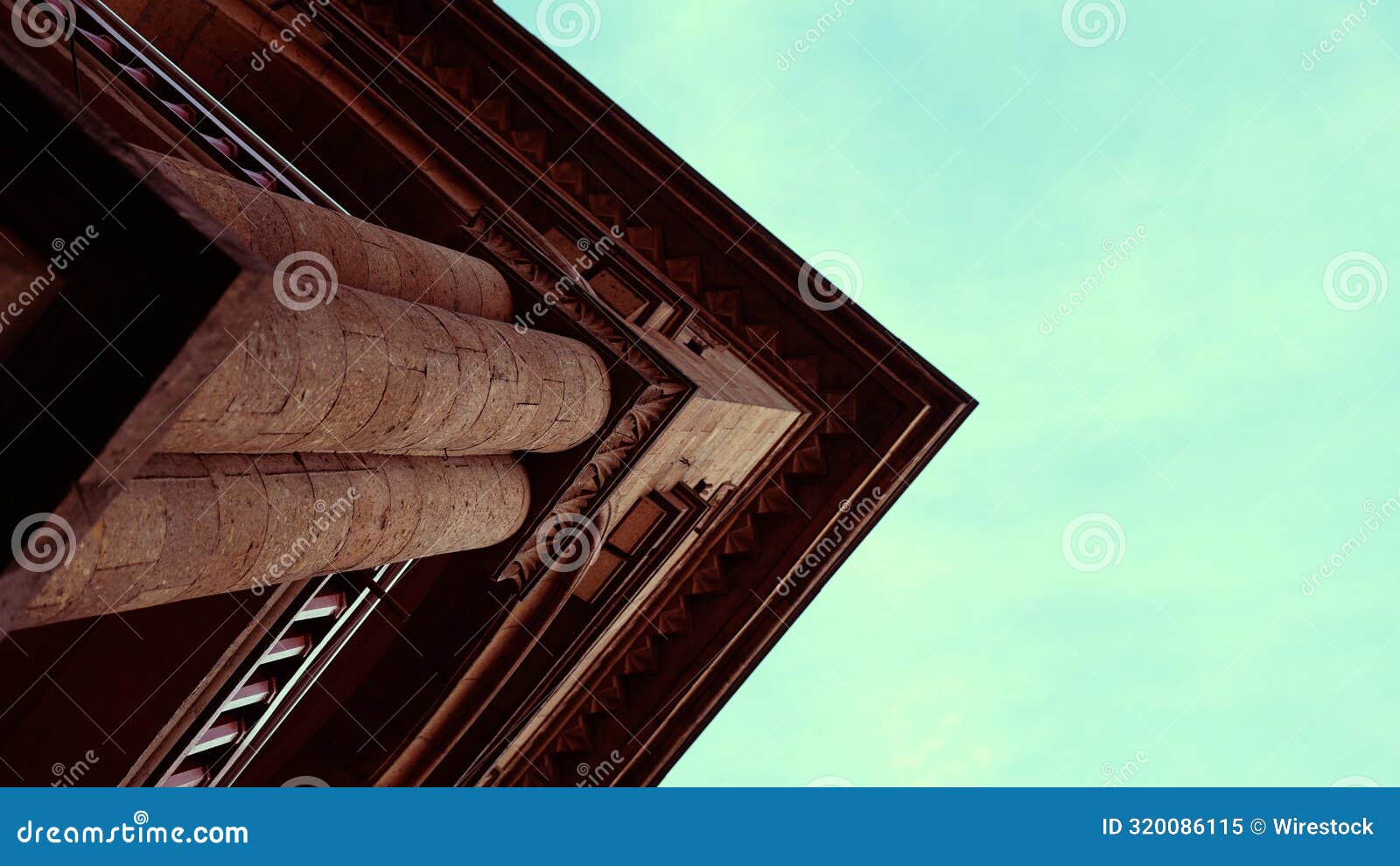 Tall Building with Columns and a Clock Tower Stock Image - Image of ...