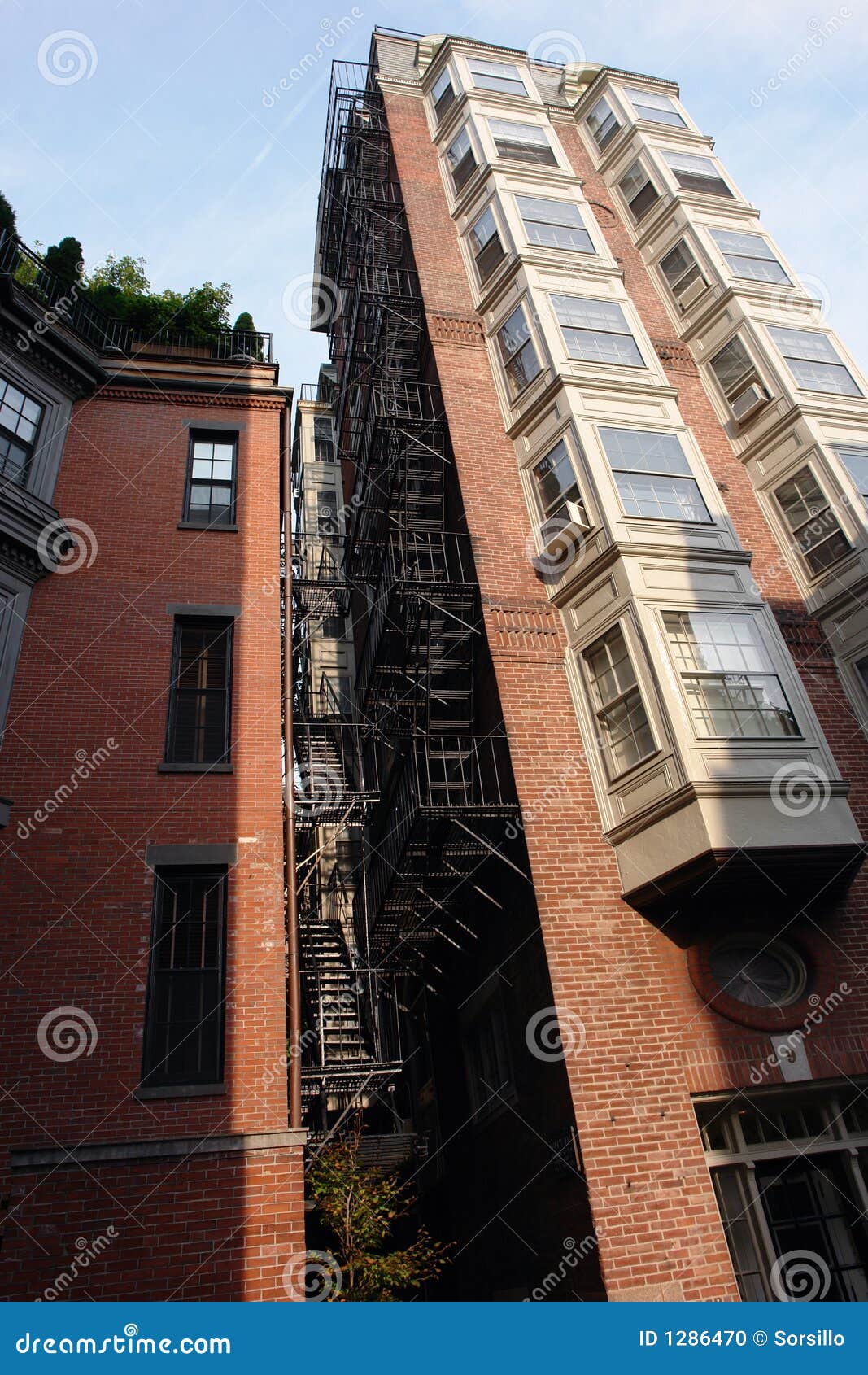 Tall Building with Fire Escape and Bay Windows Full Color Stock Photo ...