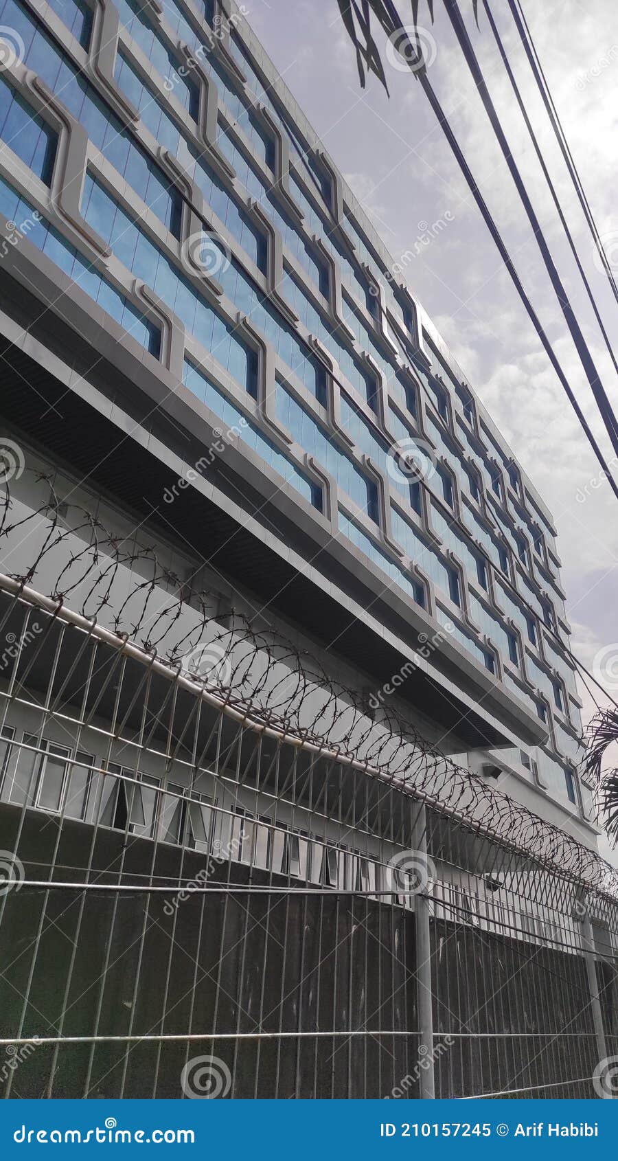 A Tall Building with Spiky Fence Under the Sky Stock Image - Image of ...