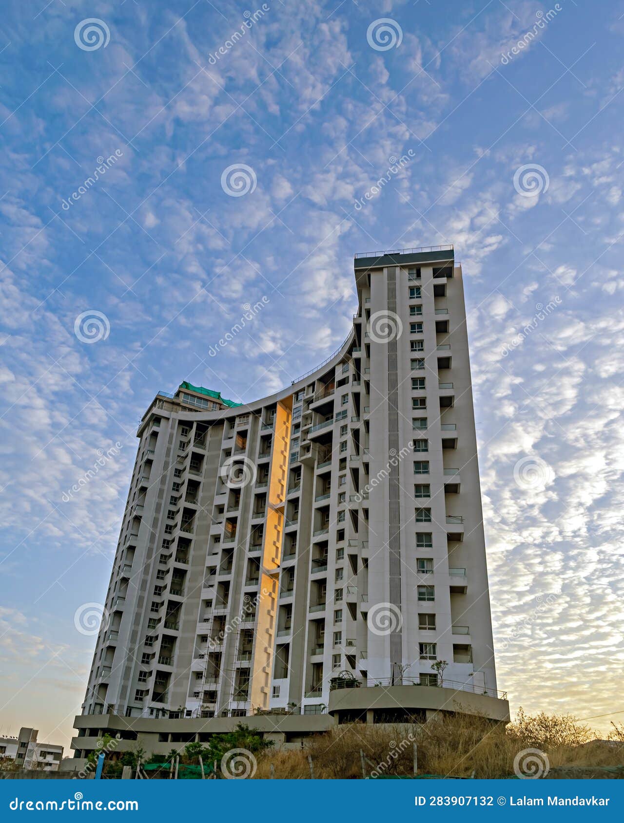 Tall City Building with a Background of Beautiful Fluffy Blue Clouds ...