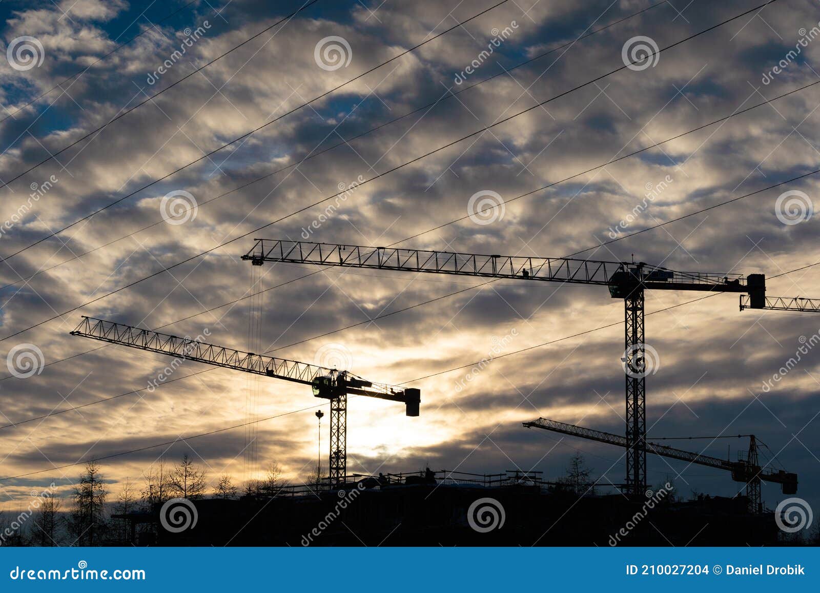 A Tall Construction Crane Against the Setting Sun. Machine for High ...