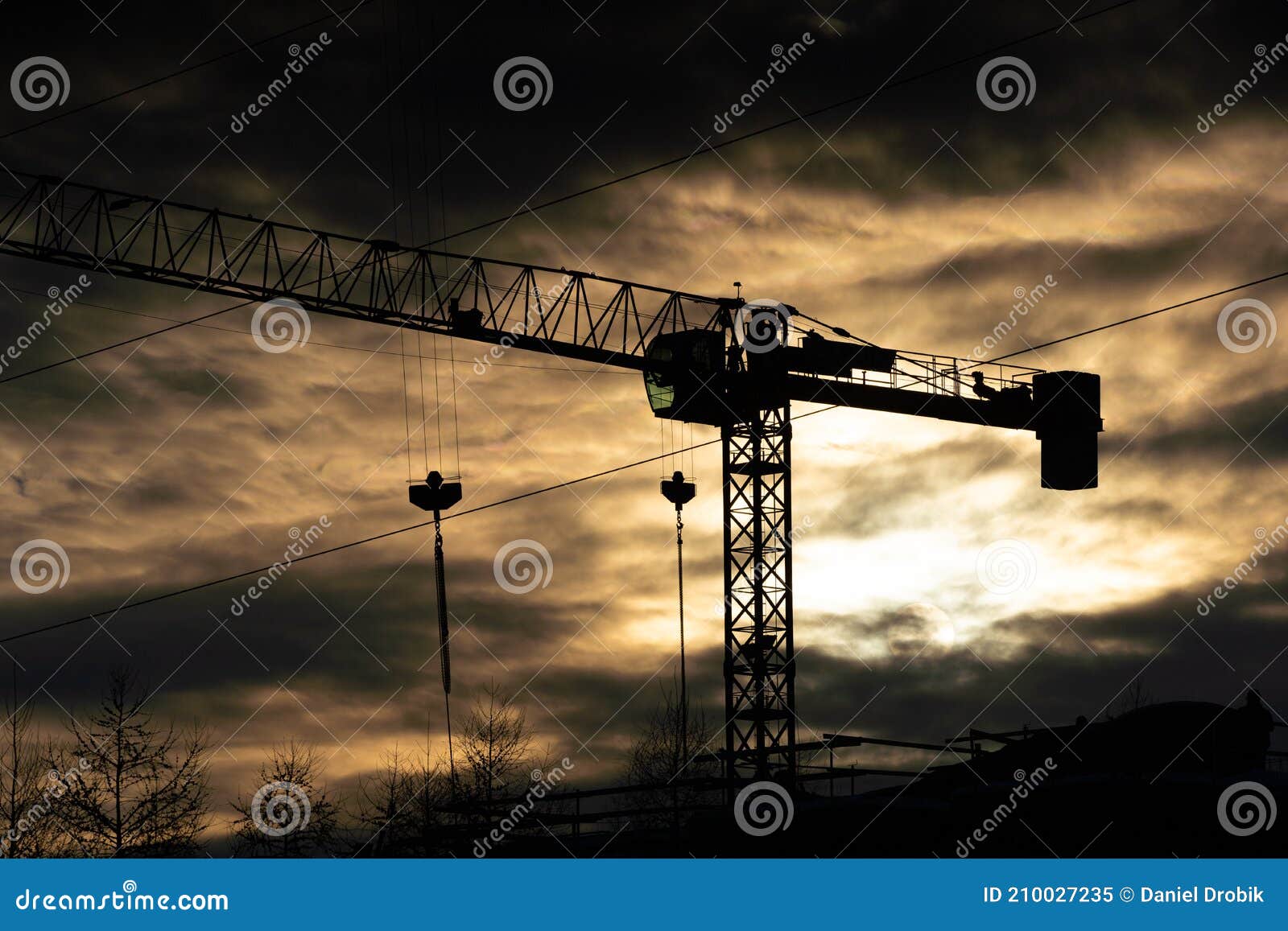 A Tall Construction Crane Against the Setting Sun. Machine for High ...