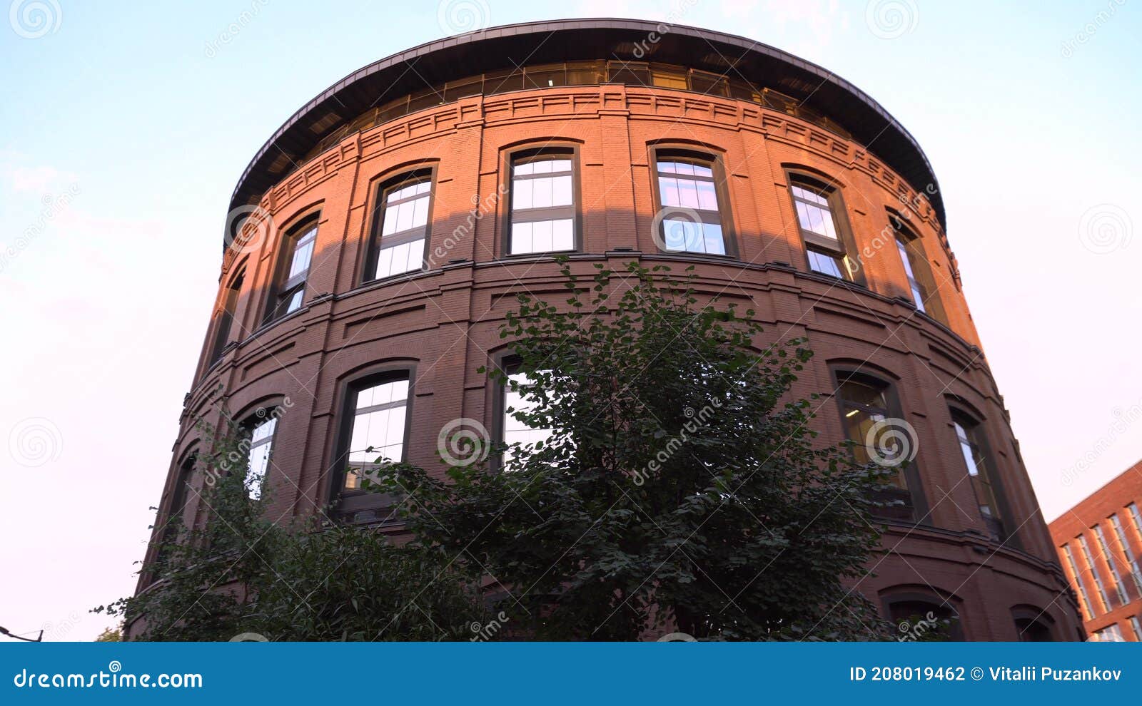 Tall Cylinder-shaped Building. View from Behind the Bushes Stock Photo ...
