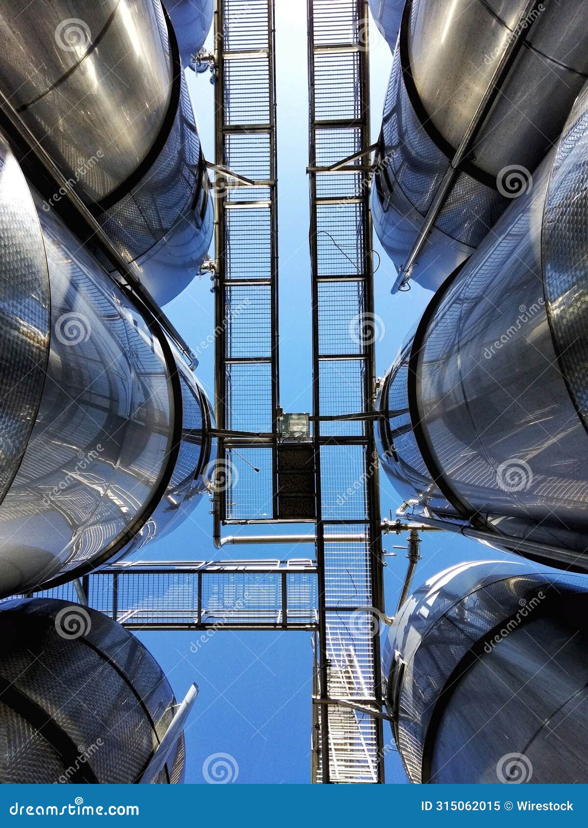 Tall Cylindrical Tanks at an Industrial Site with a Clear Sky in the ...