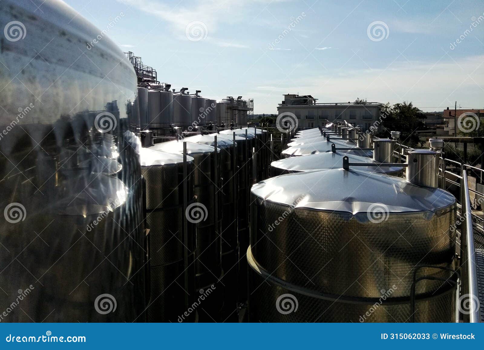 Tall Cylindrical Tanks at an Industrial Site with a Clear Sky in the ...