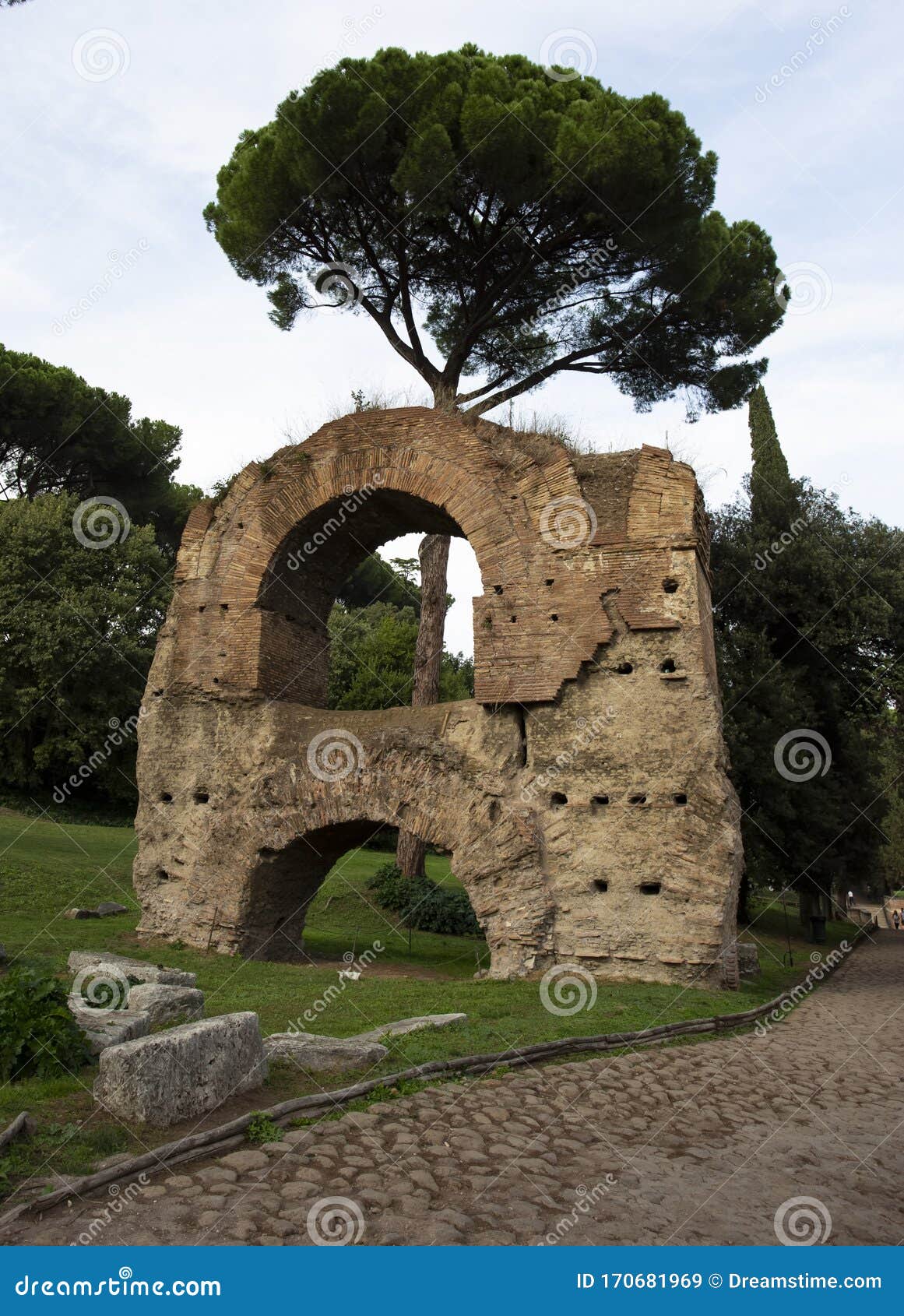 A Tall Green Tree Behind an Old Ruin in a Roman Park Stock Image ...