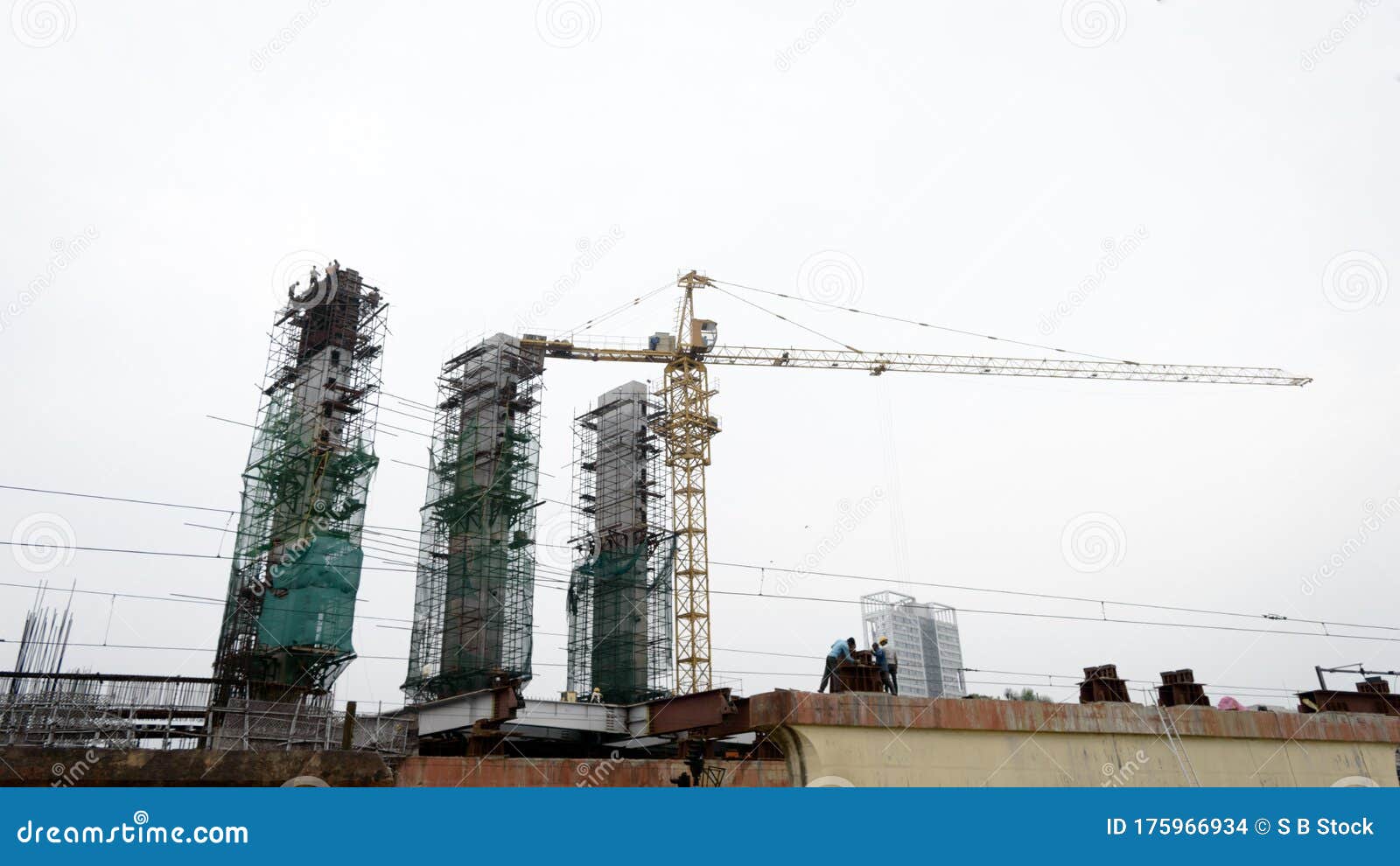 A Tall High Crane Equipment Work In Progress In A Construction Site Of ...