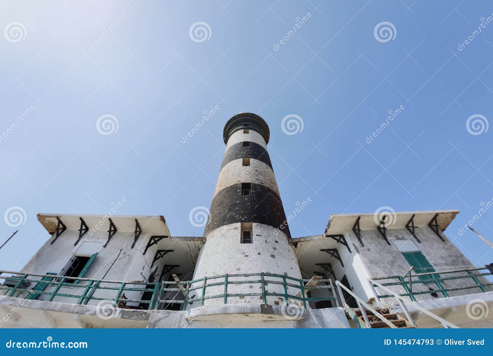 Tall lighthouse on the sea stock image. Image of travel - 145474793