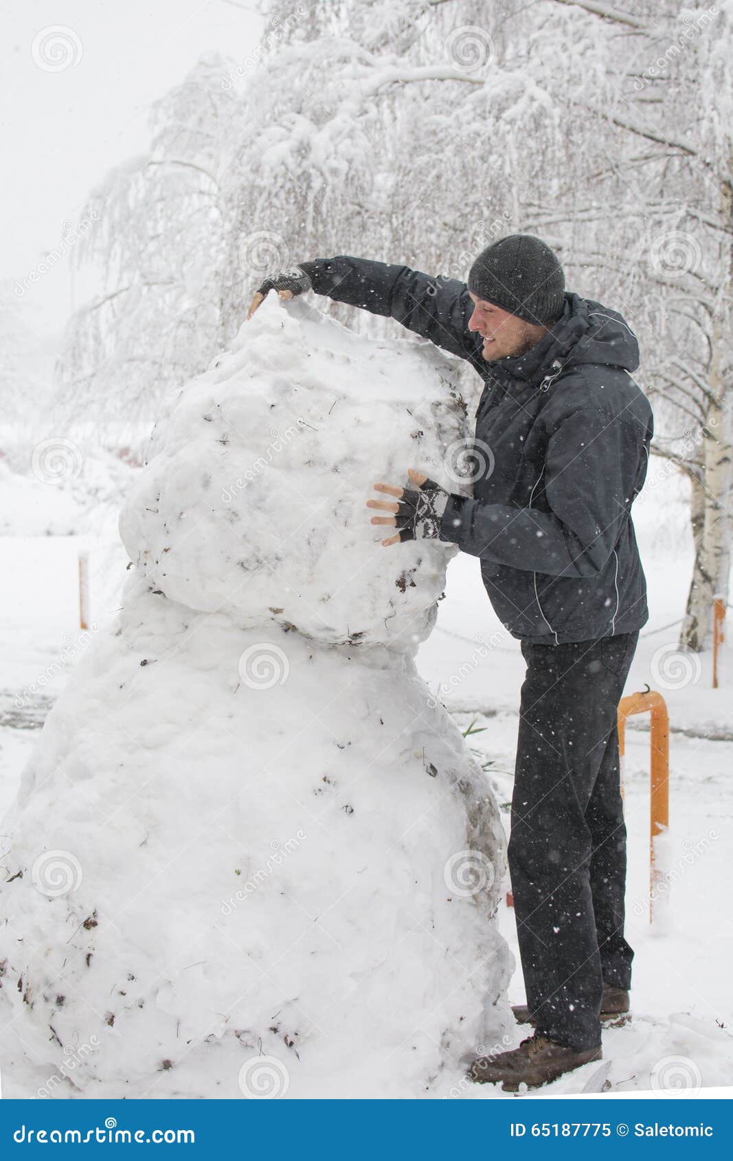 Tall Man Making really Tall Snowman Stock Image - Image of holiday ...