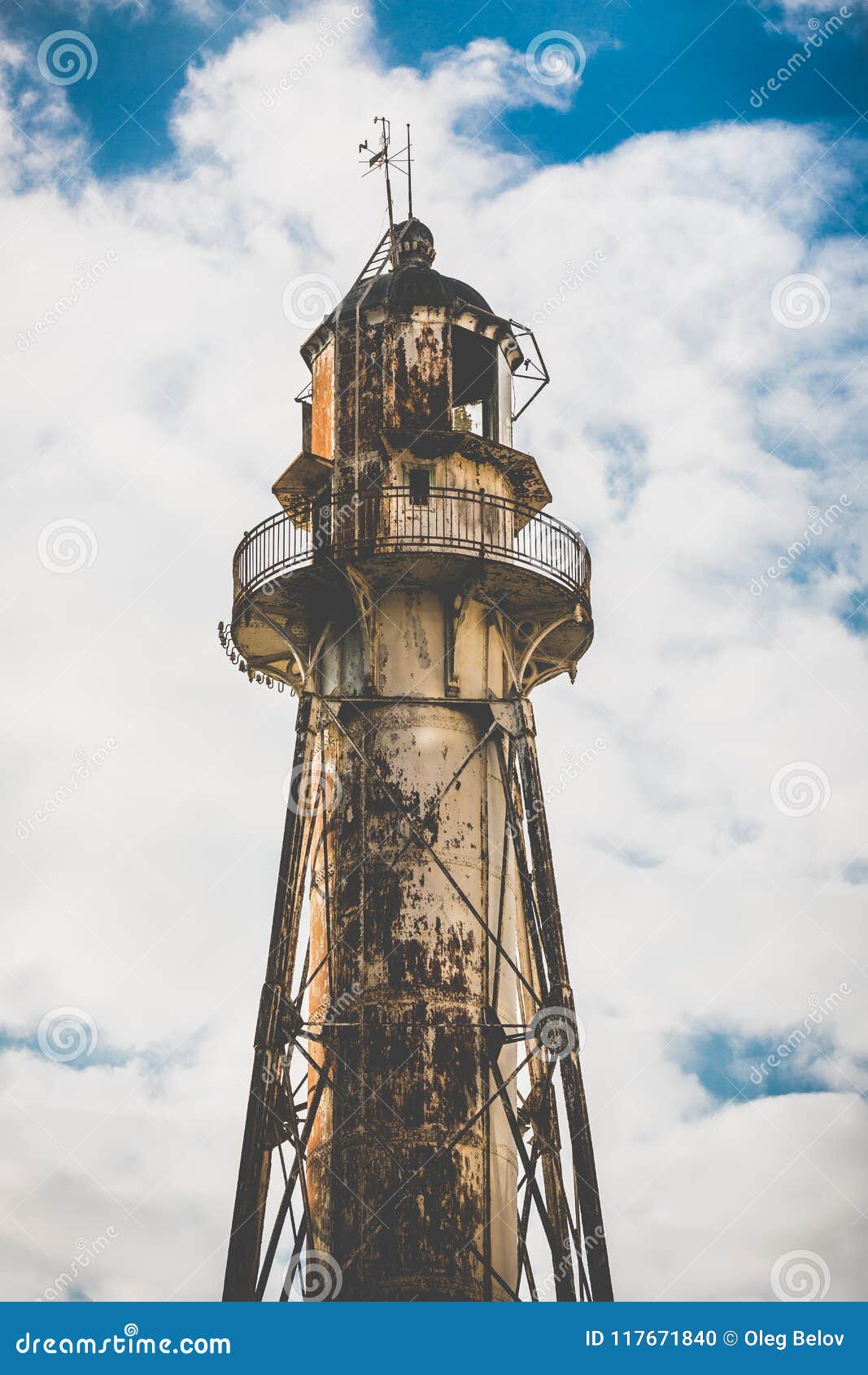 The Tall Old Rusty Metal Lighthouse on Background of a Blue Sky and ...