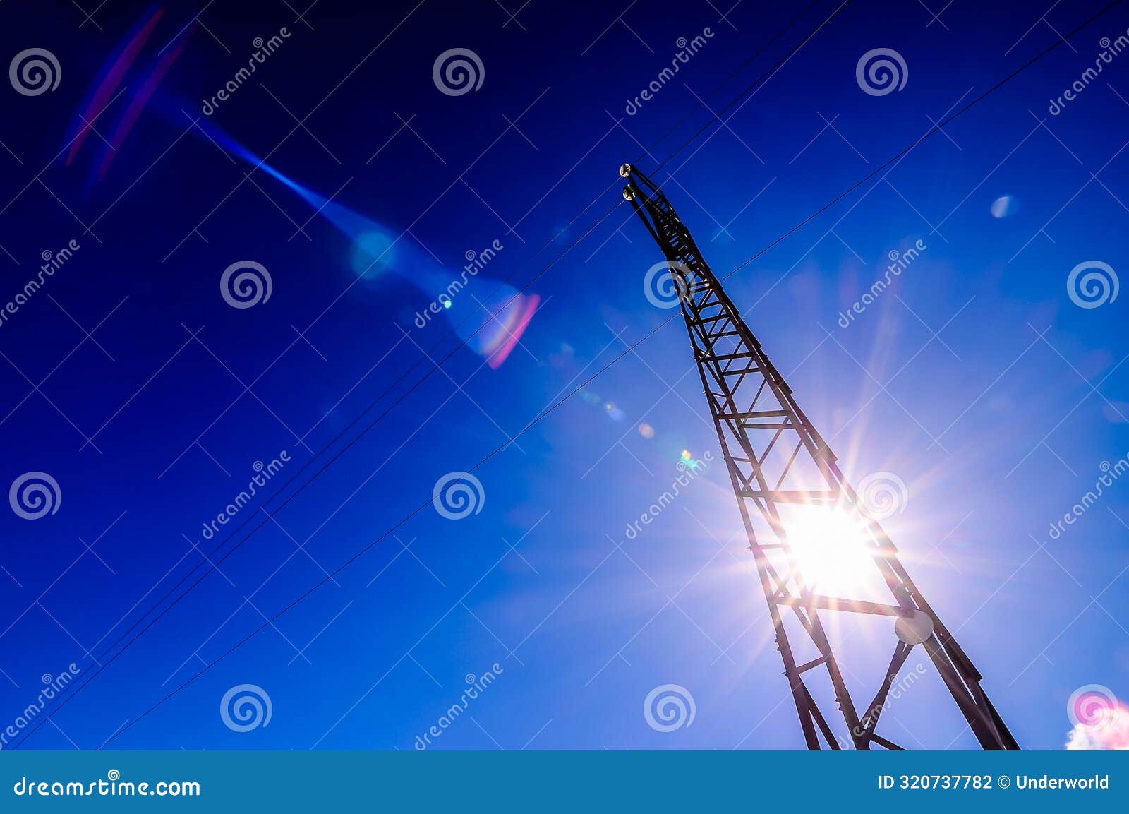 A Tall Power Pole with a Bright Sun Shining on it Stock Photo - Image ...