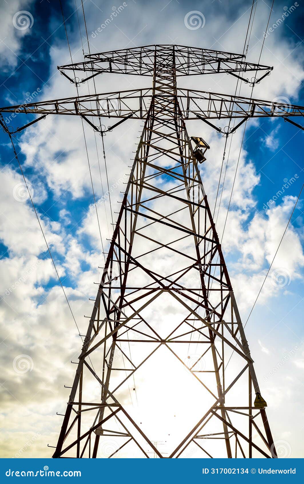 A Tall Power Tower with a Man on Top of it Stock Photo - Image of line ...