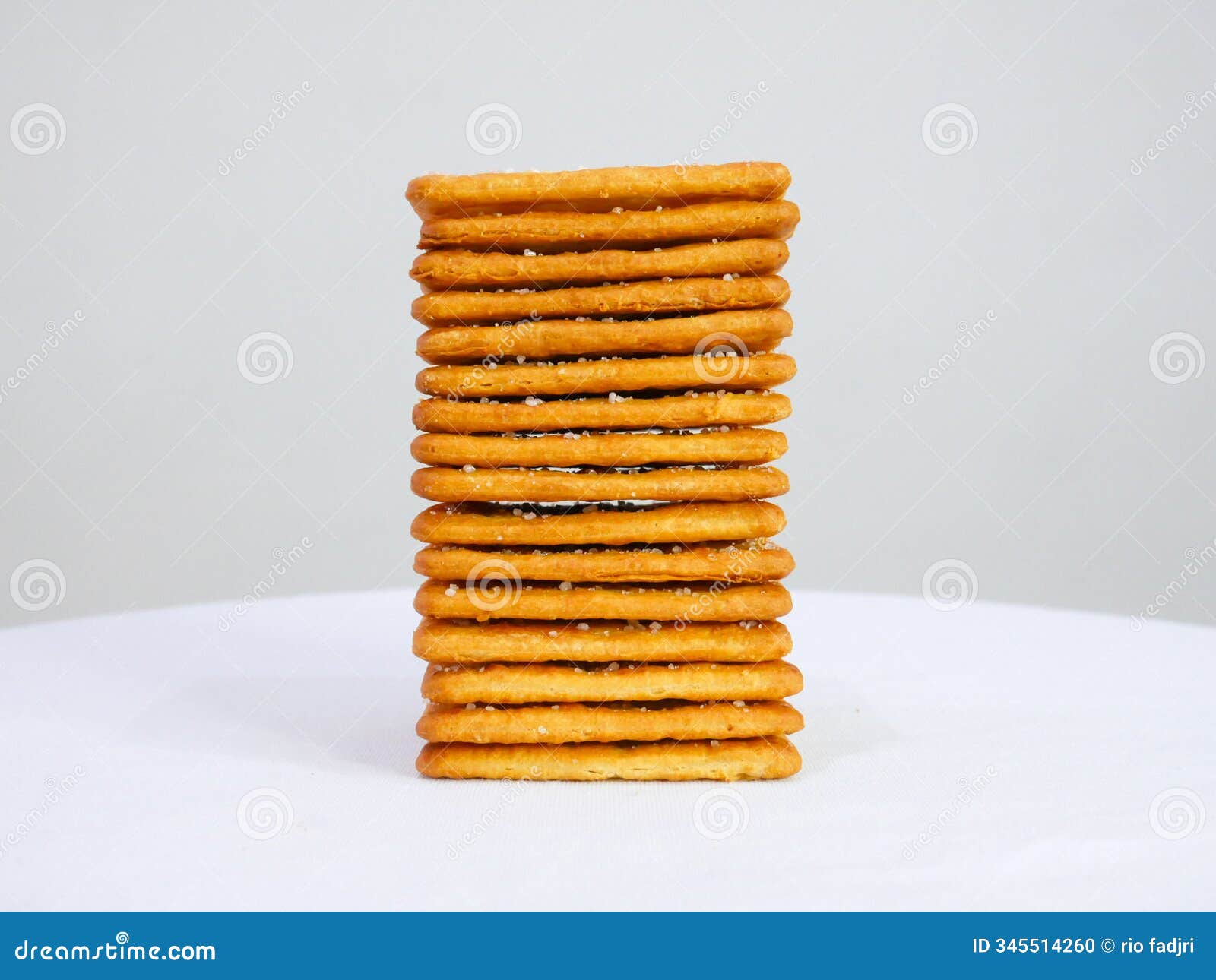 A Tall Stack of Crackers is Centered in Front of a Light Gray ...