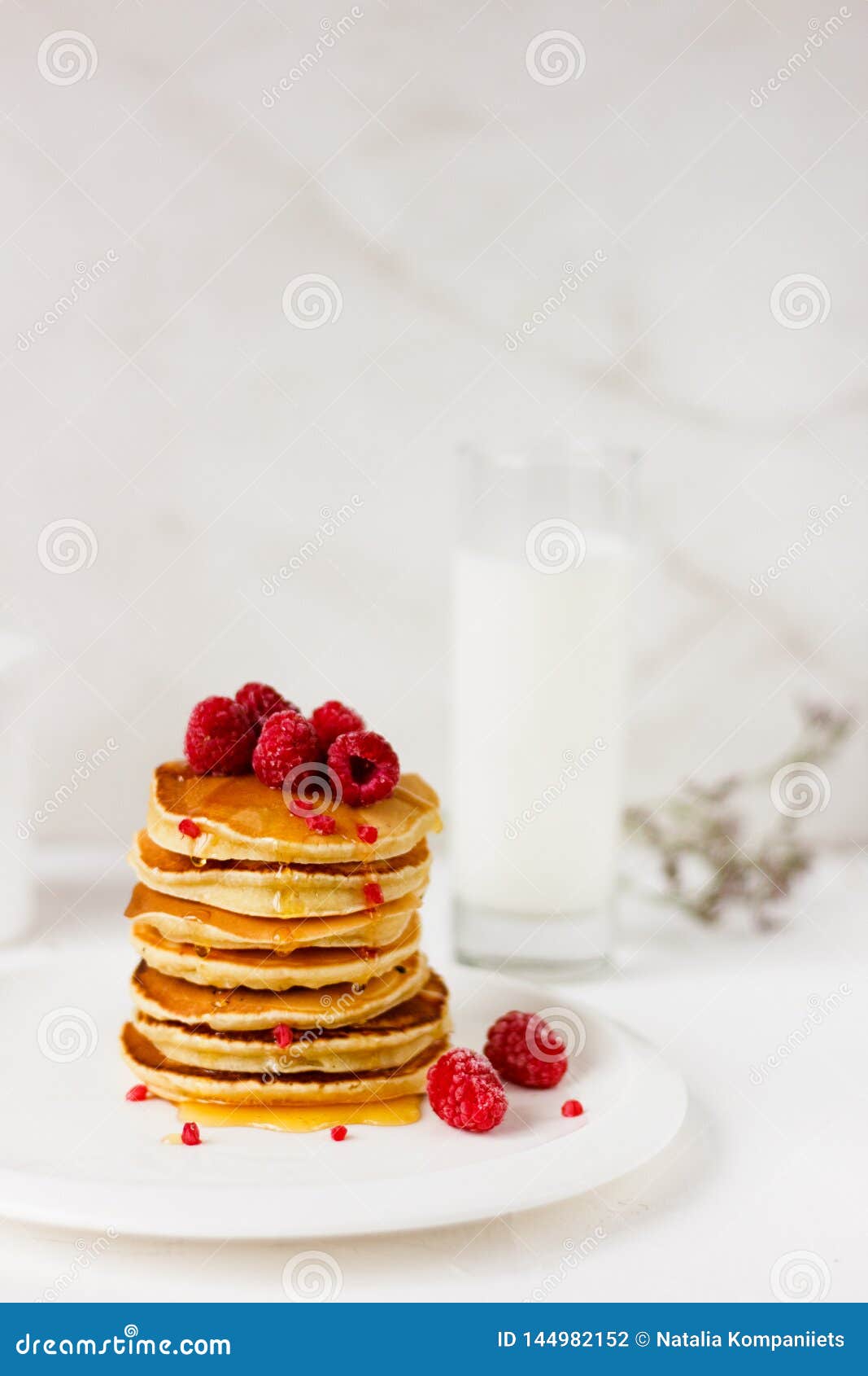 Tall Stack of Pancakes with Honey and Raspberries on White Plate. Stock ...