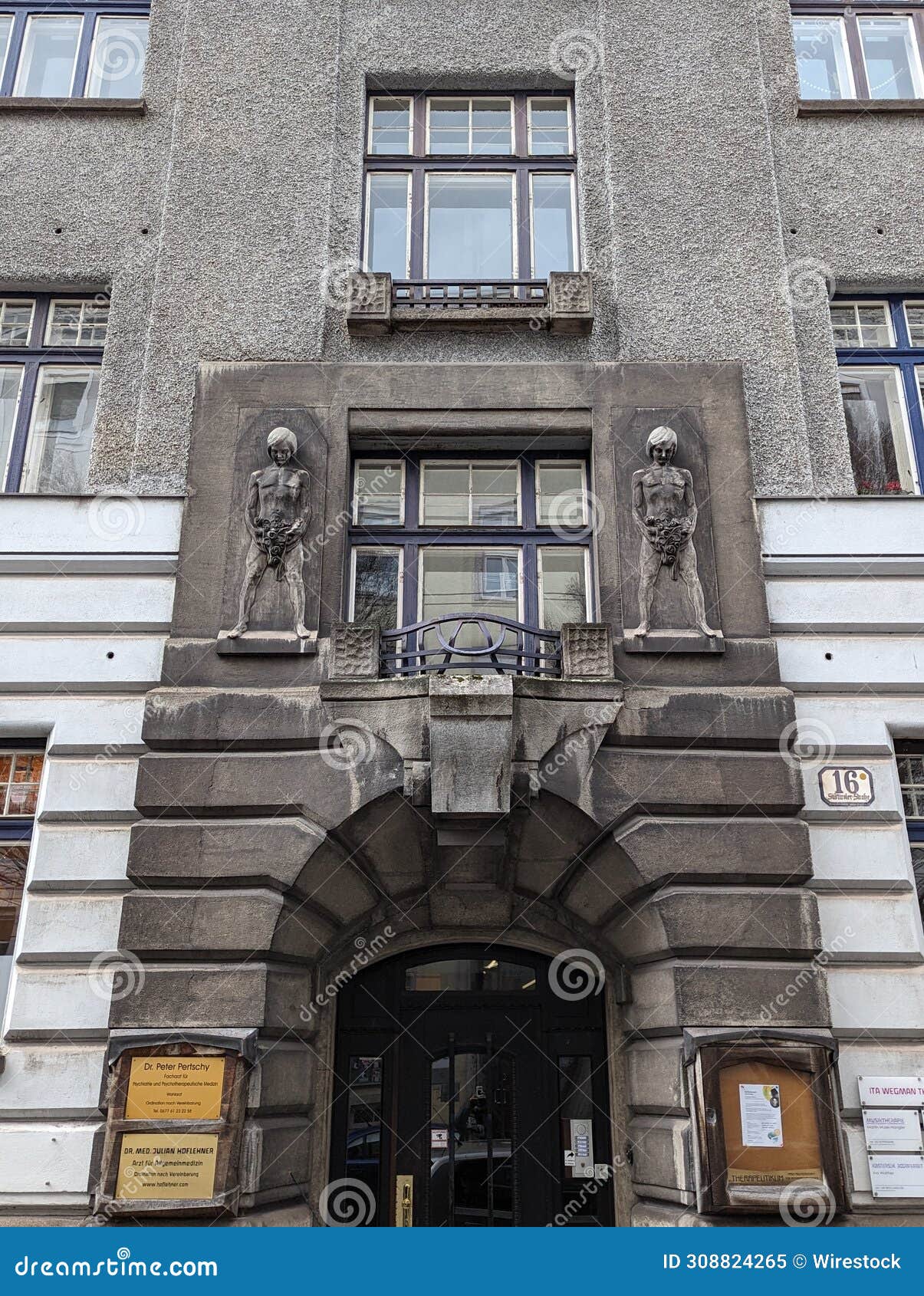 Tall Structure with Two Sculptures and a Clock on Its Side in Linz ...