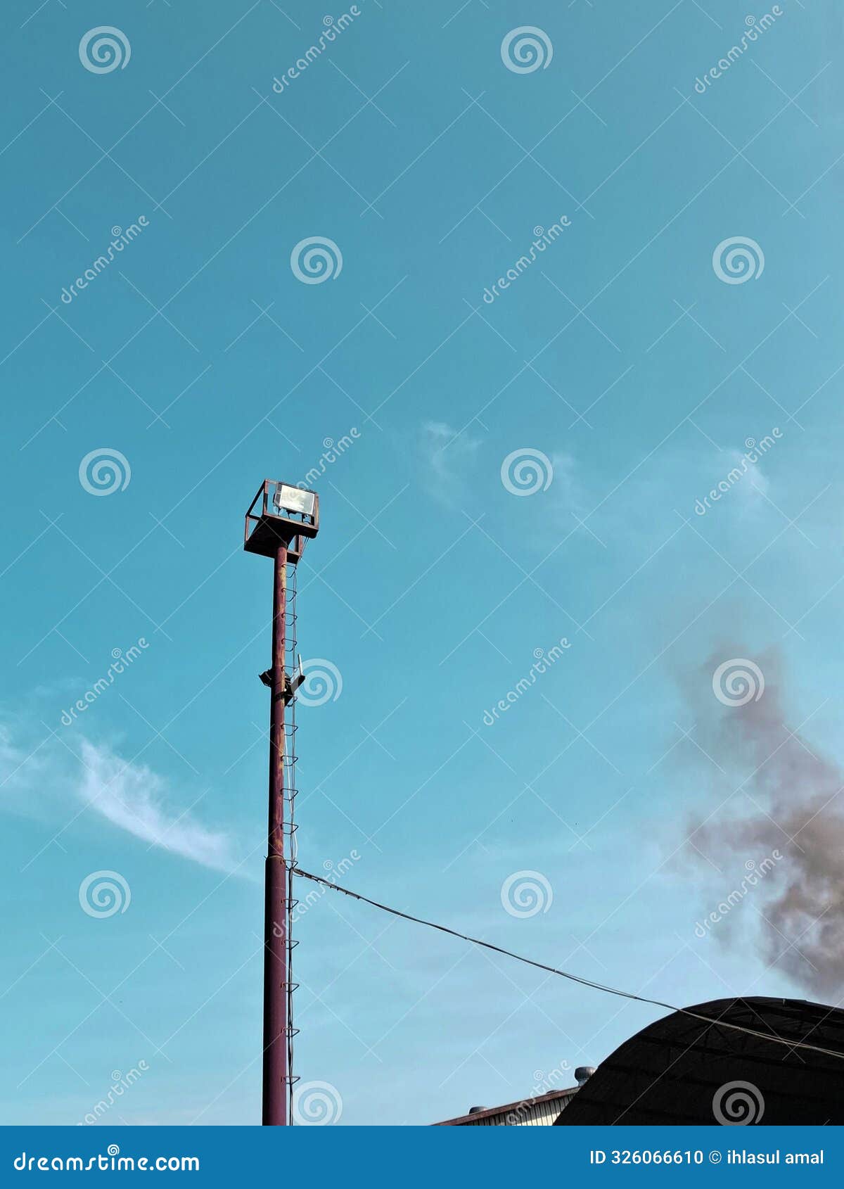 A Tall Tower with Lights on Top with Beautiful Blue Sky Stock Photo ...