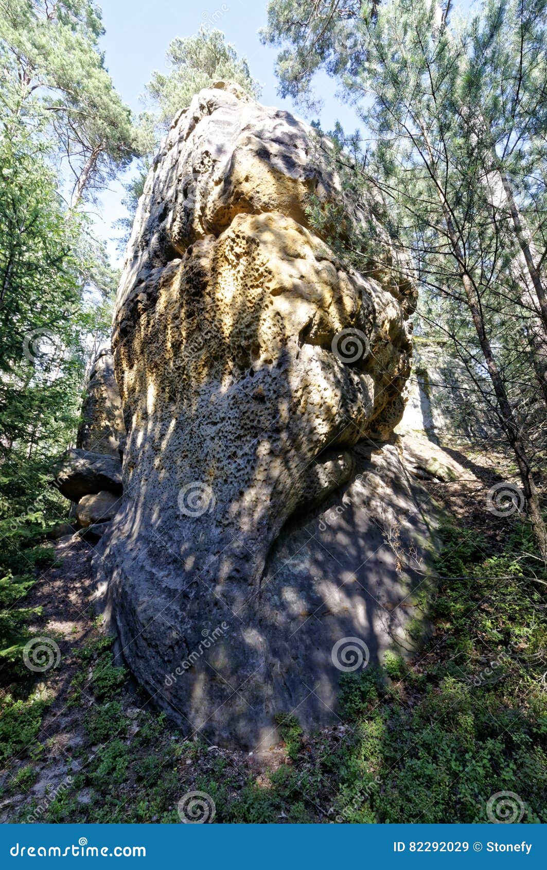 Tall and Unique Rock Formation with Shadows of Trees Falling on it ...