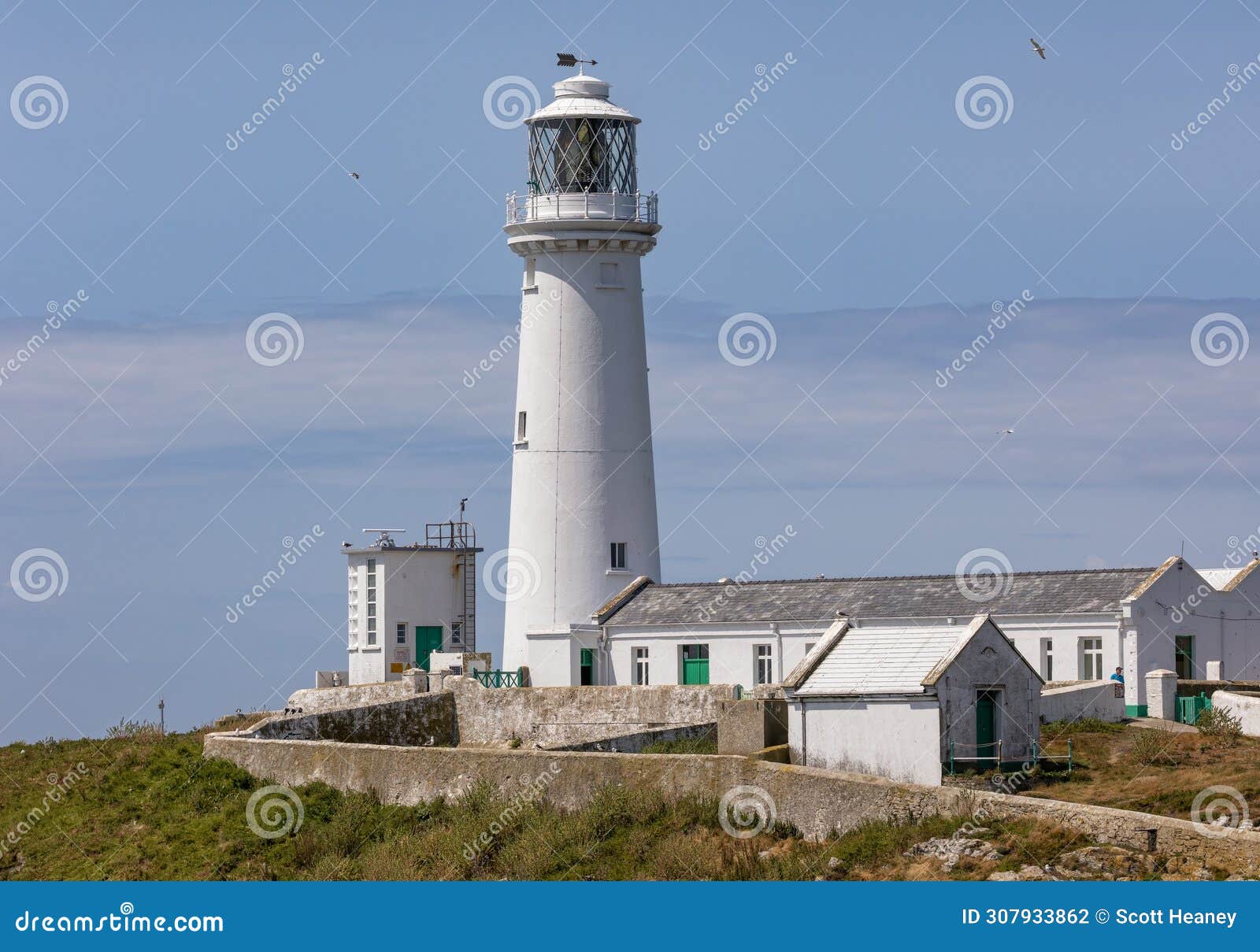 Tall White Stone Lighthouse at the Edge of the Cliffs on a Rugged ...