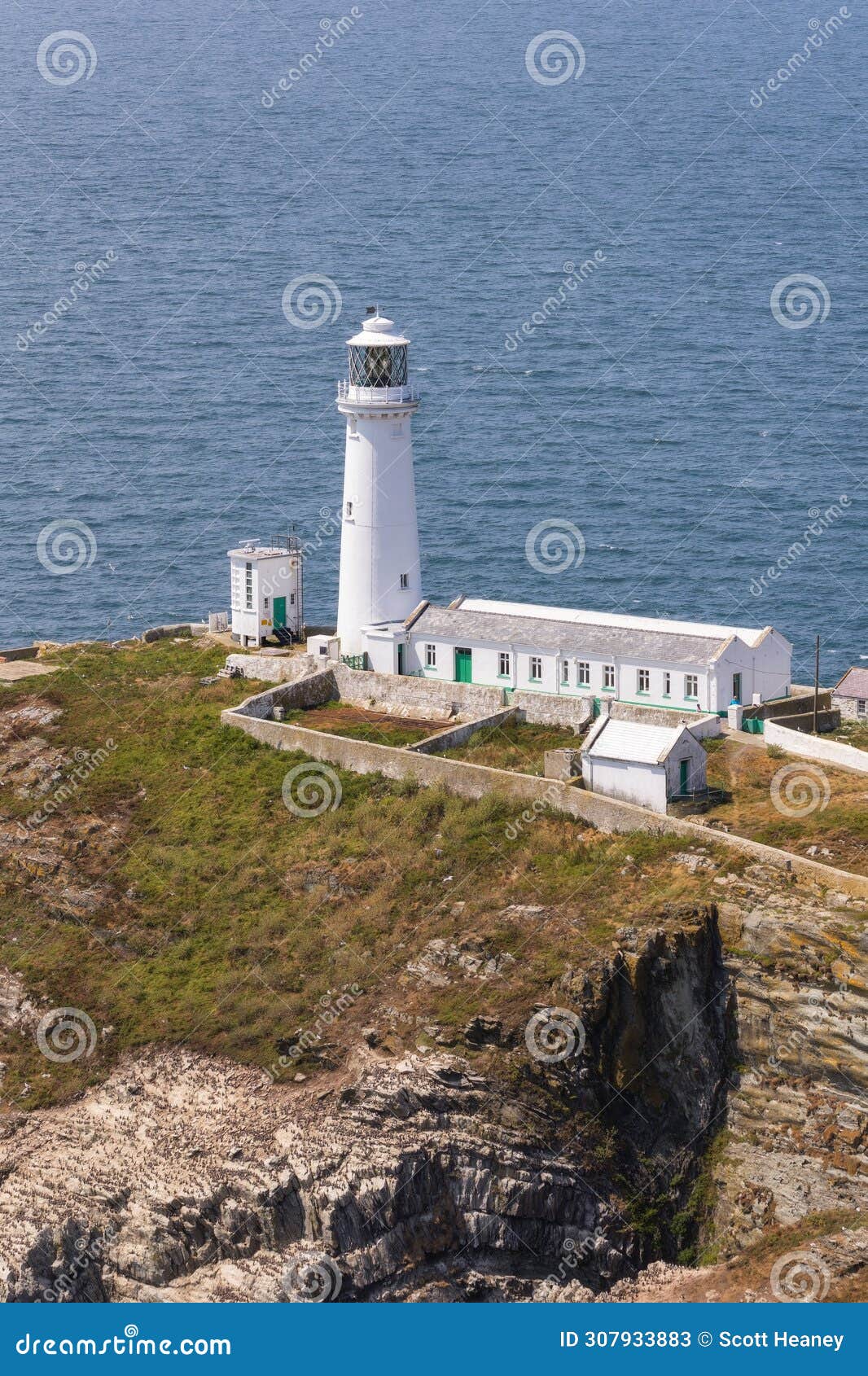 Tall White Stone Lighthouse at the Edge of the Cliffs on a Rugged ...