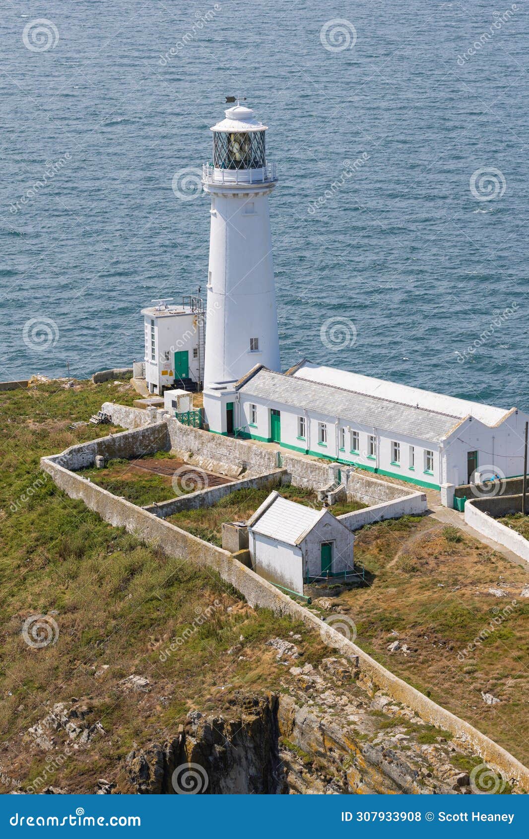 Tall White Stone Lighthouse at the Edge of the Cliffs on a Rugged ...
