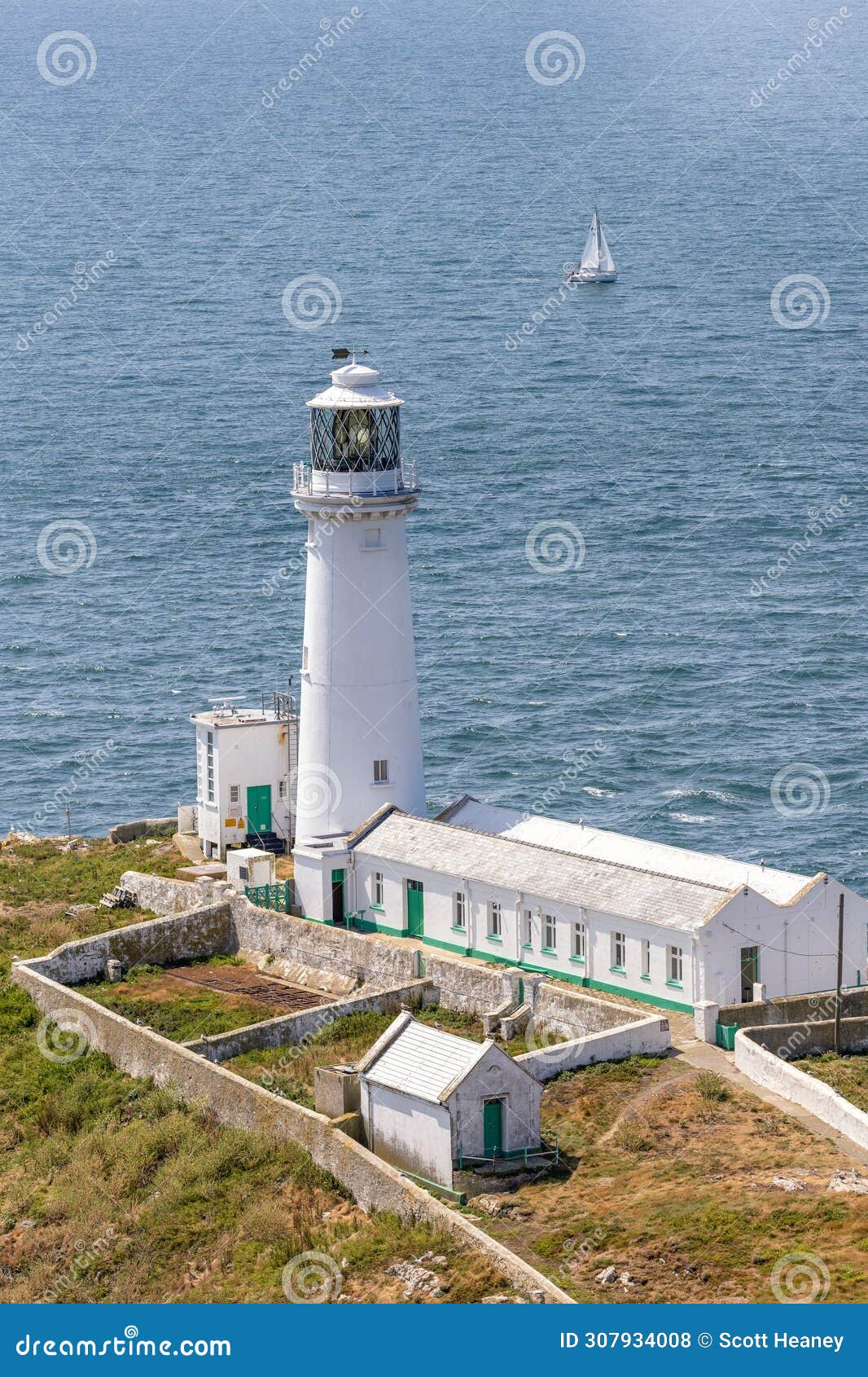 Tall White Stone Lighthouse at the Edge of the Cliffs on a Rugged ...