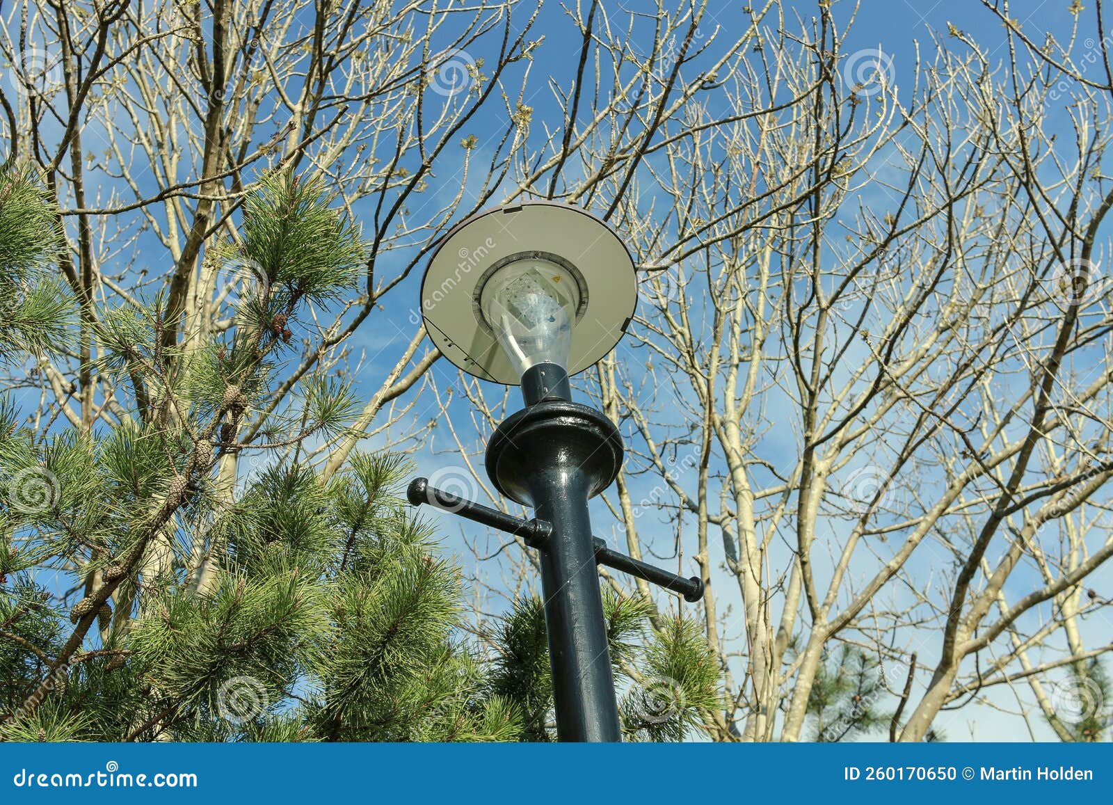 Tall White Topped Light on a Black Pole Stock Photo - Image of bright ...