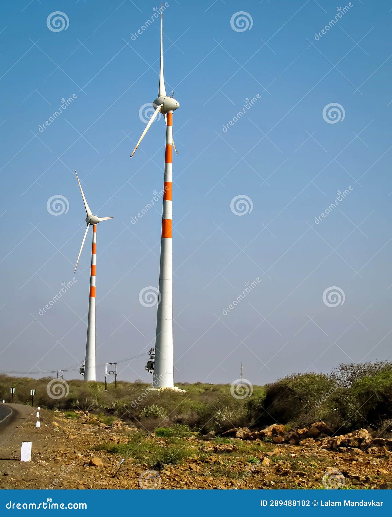 Tall Windmills Distributed in an Open Field with Nice, Clear Blue Sky ...