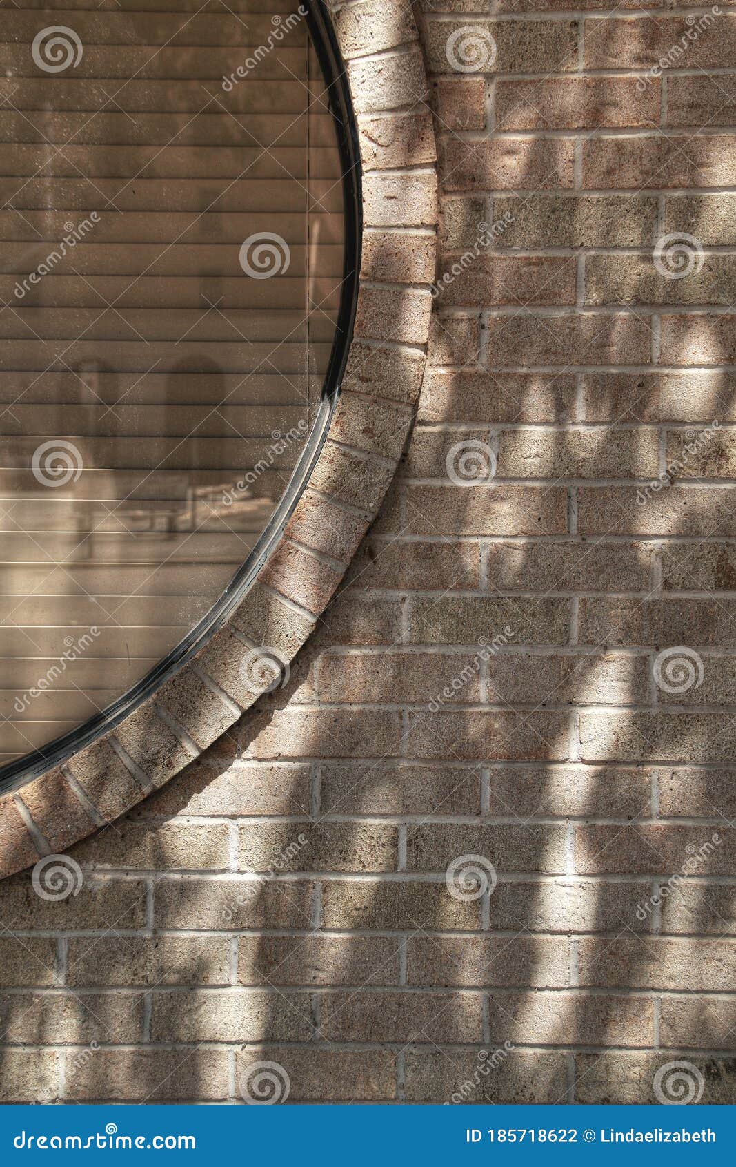 Tan Brick Wall with Section of Circular Window Covered by Blinds Stock ...