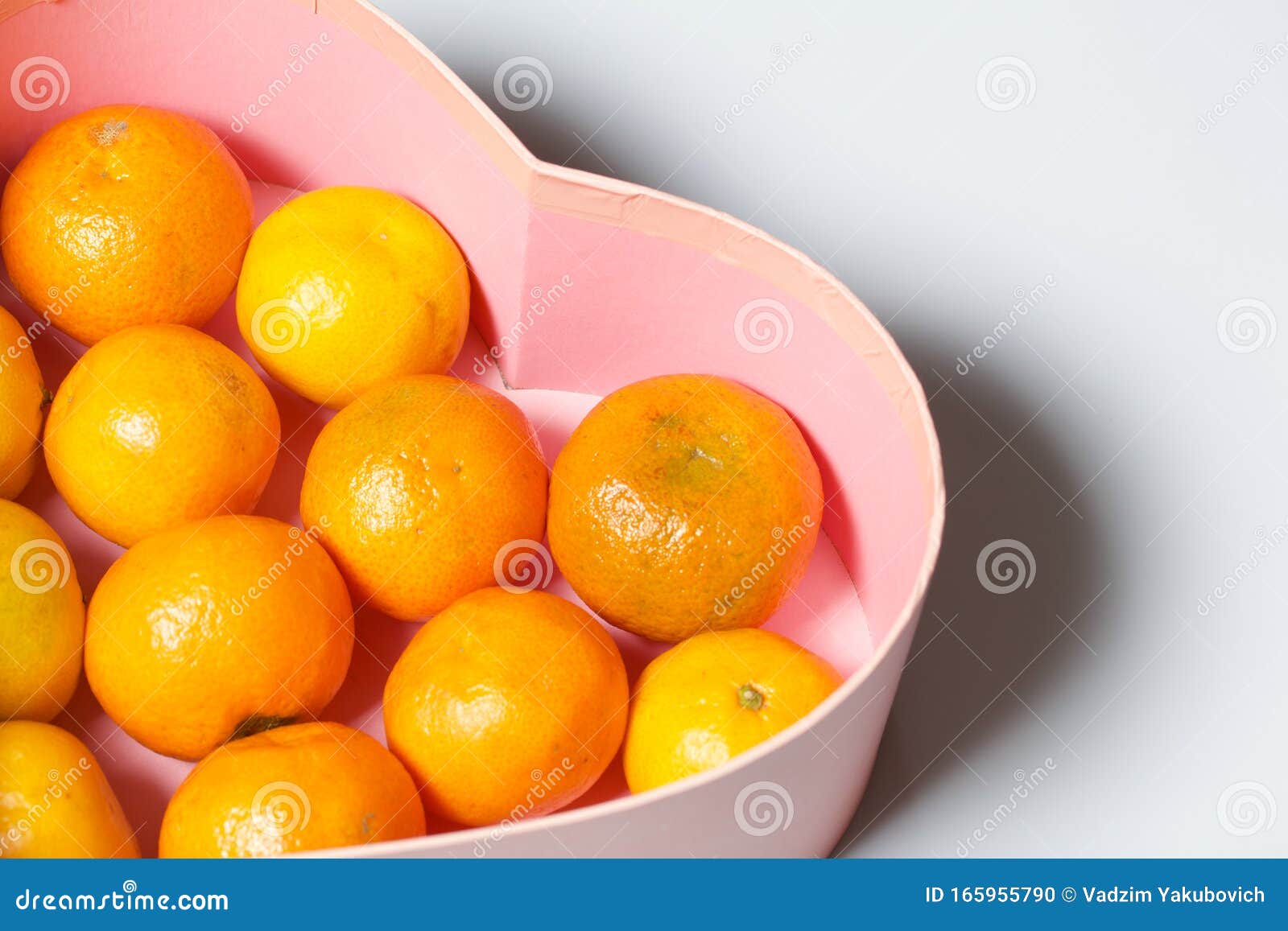 Tangerines are Stacked in a Container in the Shape of a Heart. on White ...