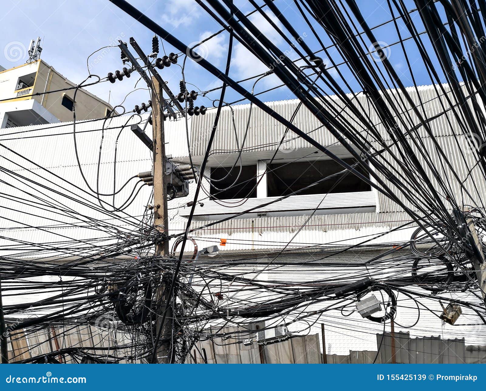 Tangle of Electrical Cables and Communication Wires on Electric Pole ...