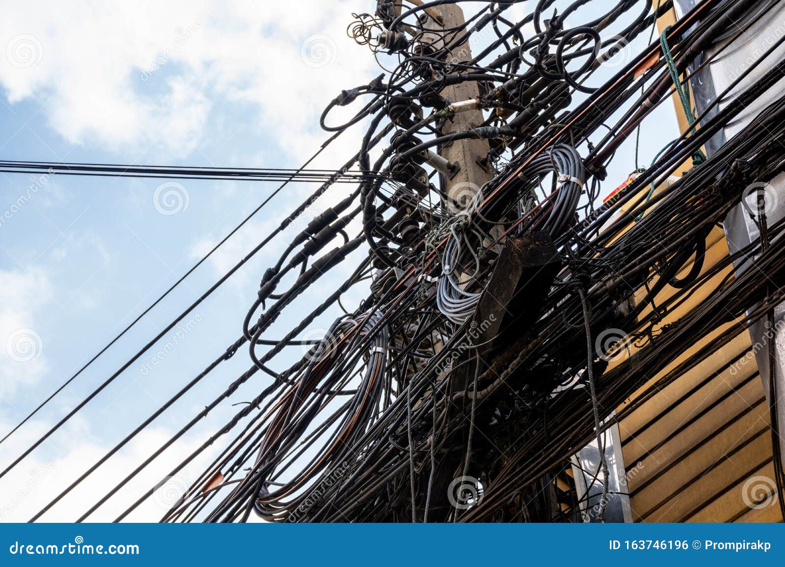 Tangle of Electrical Cables and Communication Wires on Electric Pole ...