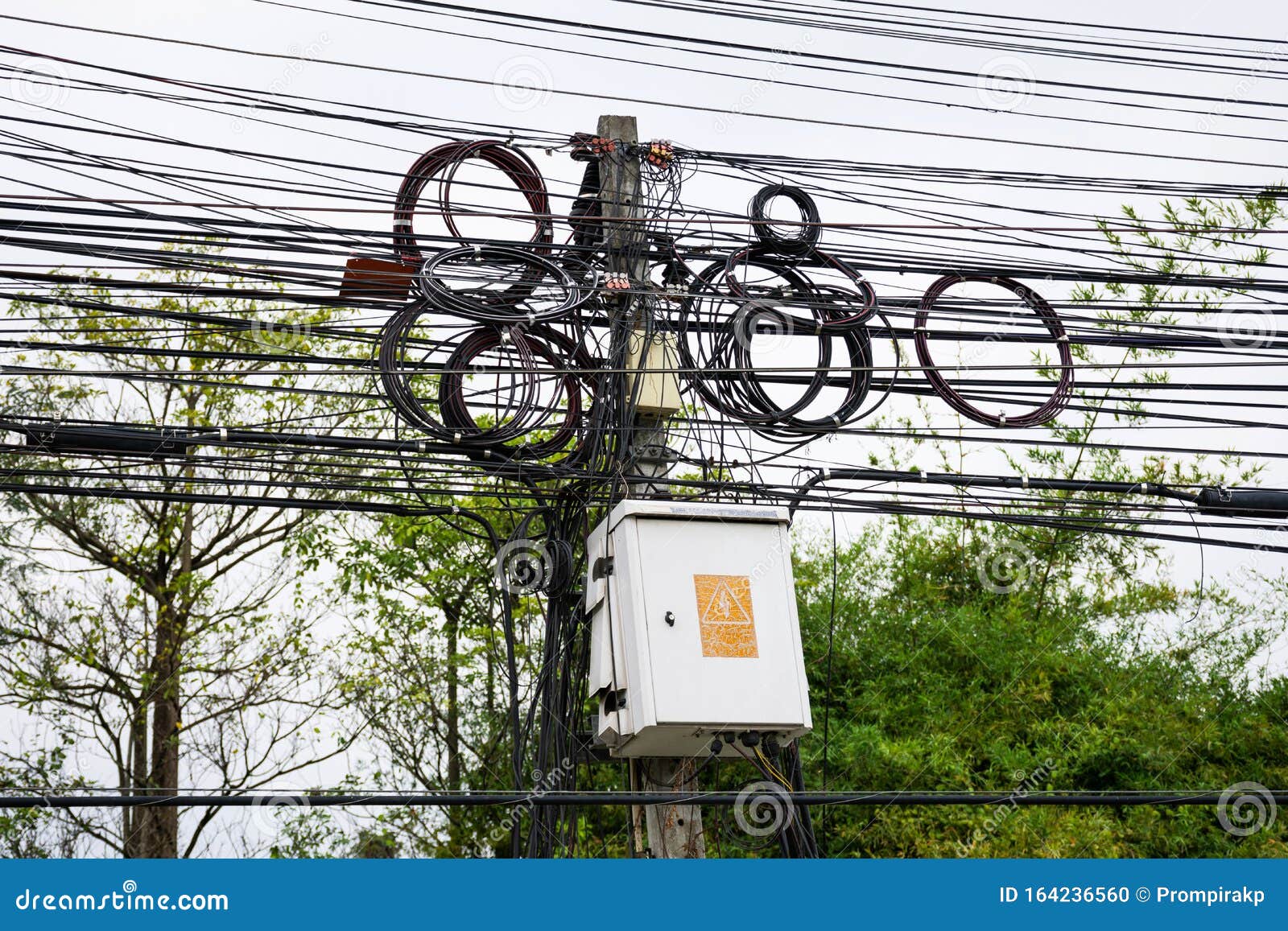 Tangle of Electrical Cables and Communication Wires on Electric Pole ...