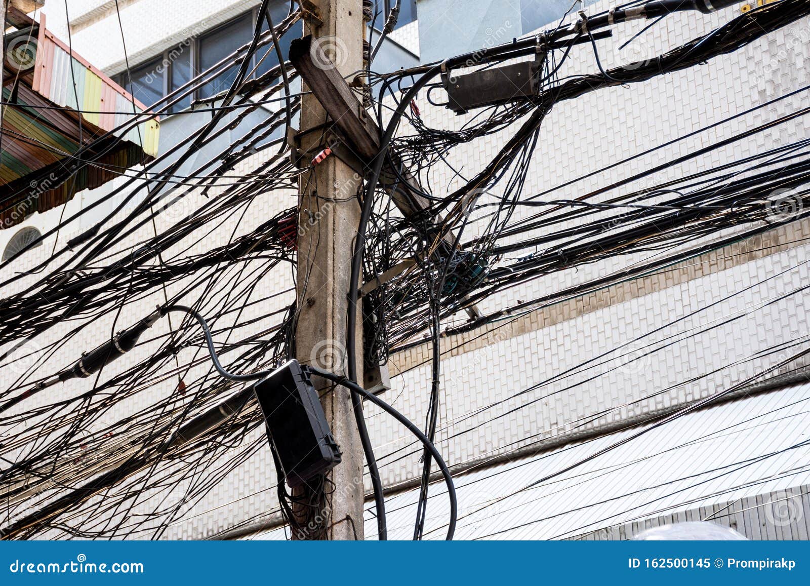 Tangle of Electrical Cables and Communication Wires on Electric Pole ...