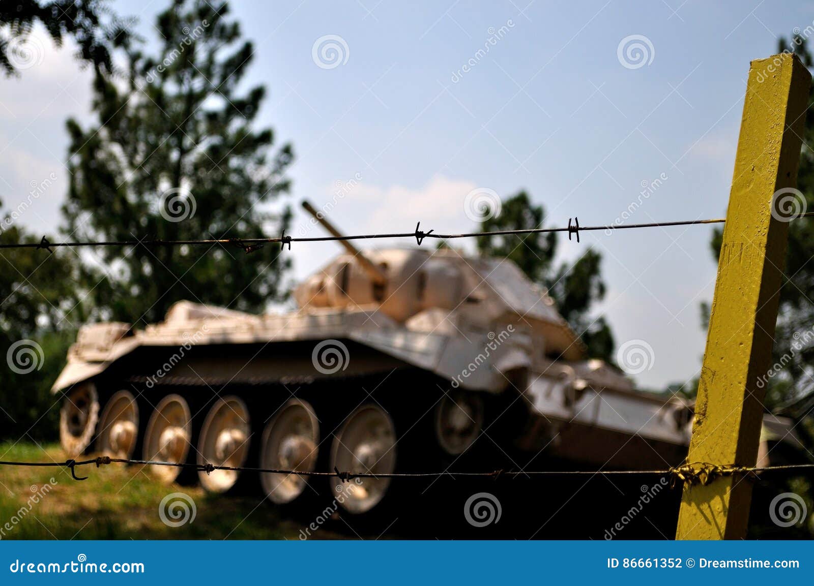 Tank behind barbed wire stock photo. Image of barbed - 86661352