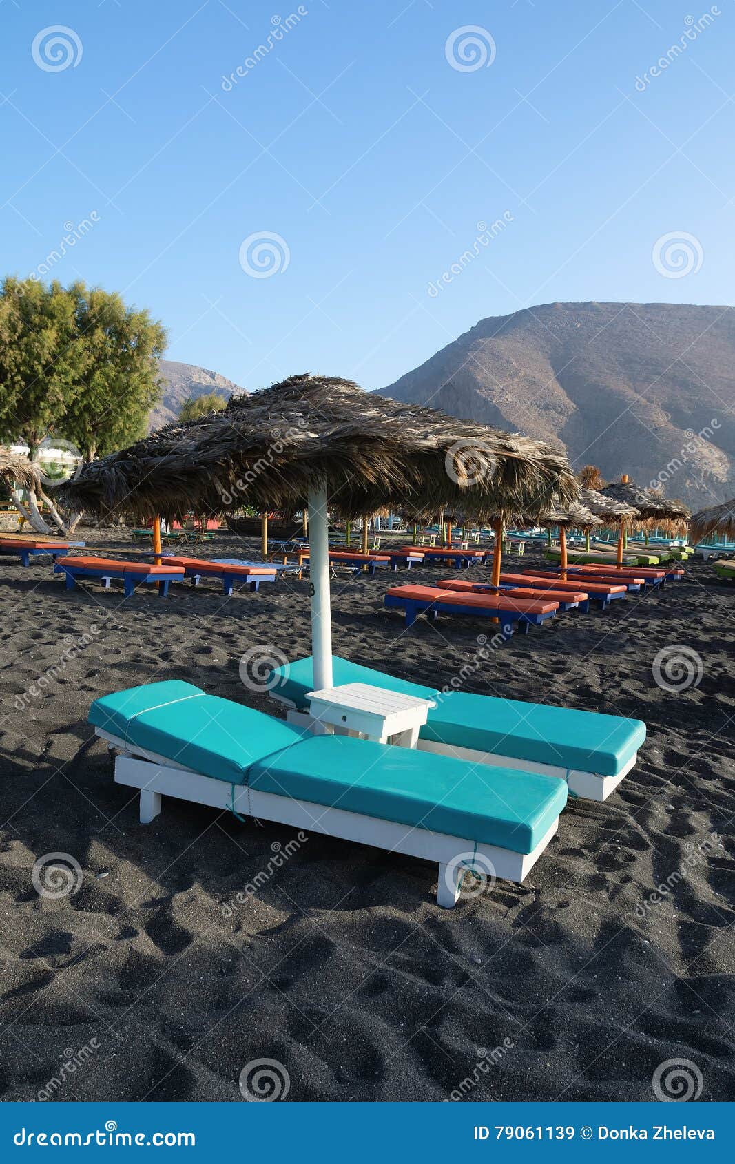 Tanning Beds and Umbrellas on Perissa Beach, Santorini, Greece Stock ...