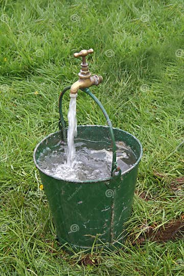 Tap and bucket stock image. Image of bucket, drink, grass - 20719965