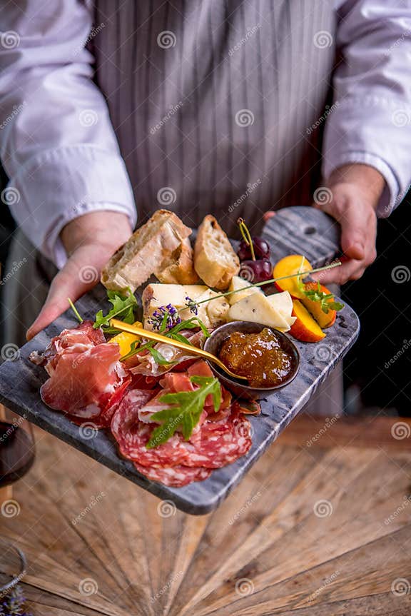 Tapas on Plate in Chefs Hands Stock Photo - Image of board, delicious ...