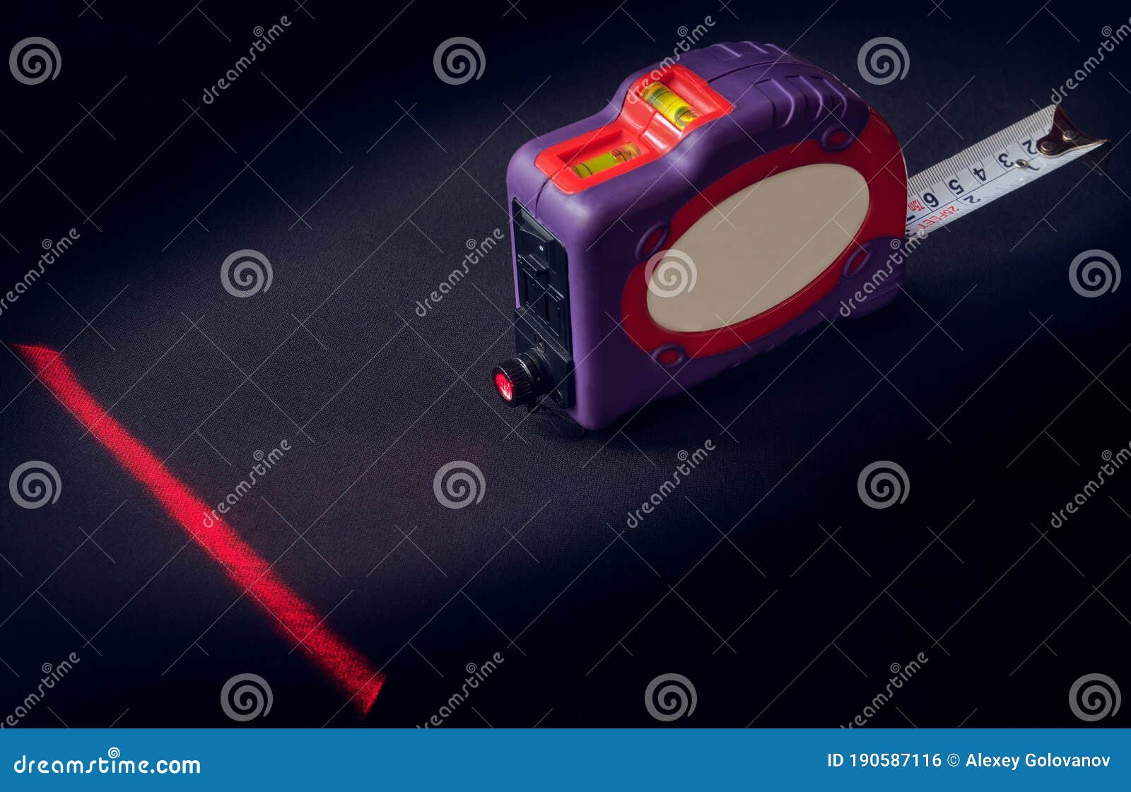Tape Measure with Laser Level on Dark Background Stock Photo - Image of ...