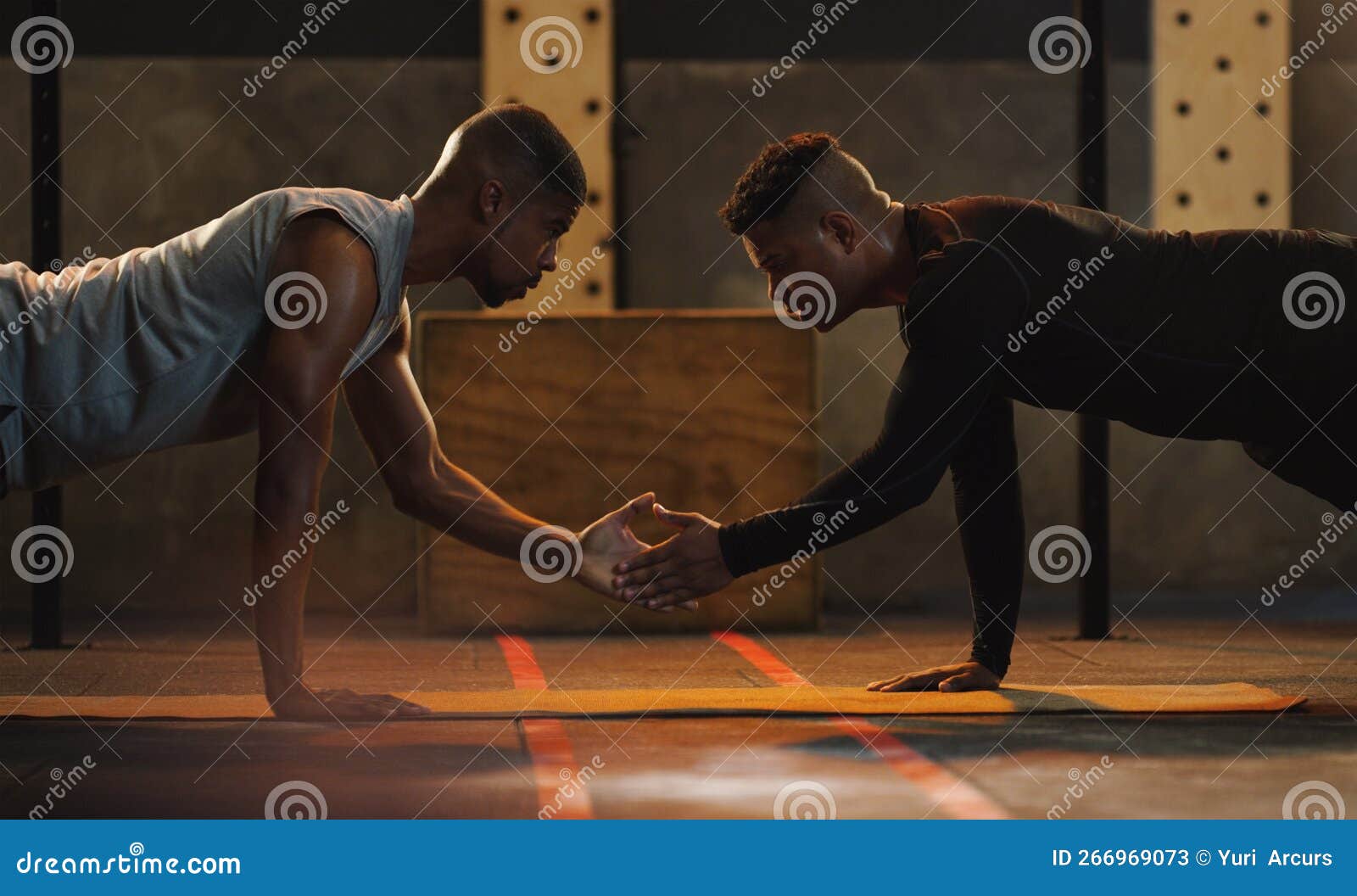 Tapping into an Intense Workout. Two Young Men Doing Pushups Together ...