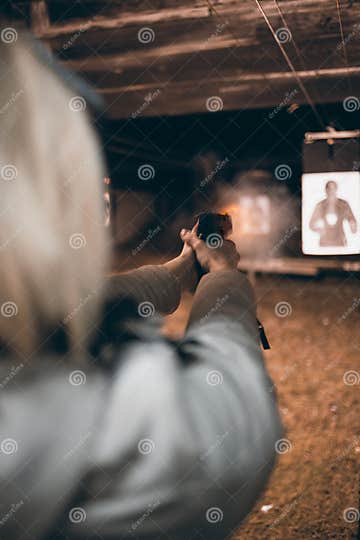 Woman Shooting with Gun at Target in Shooting Range Stock Photo - Image ...