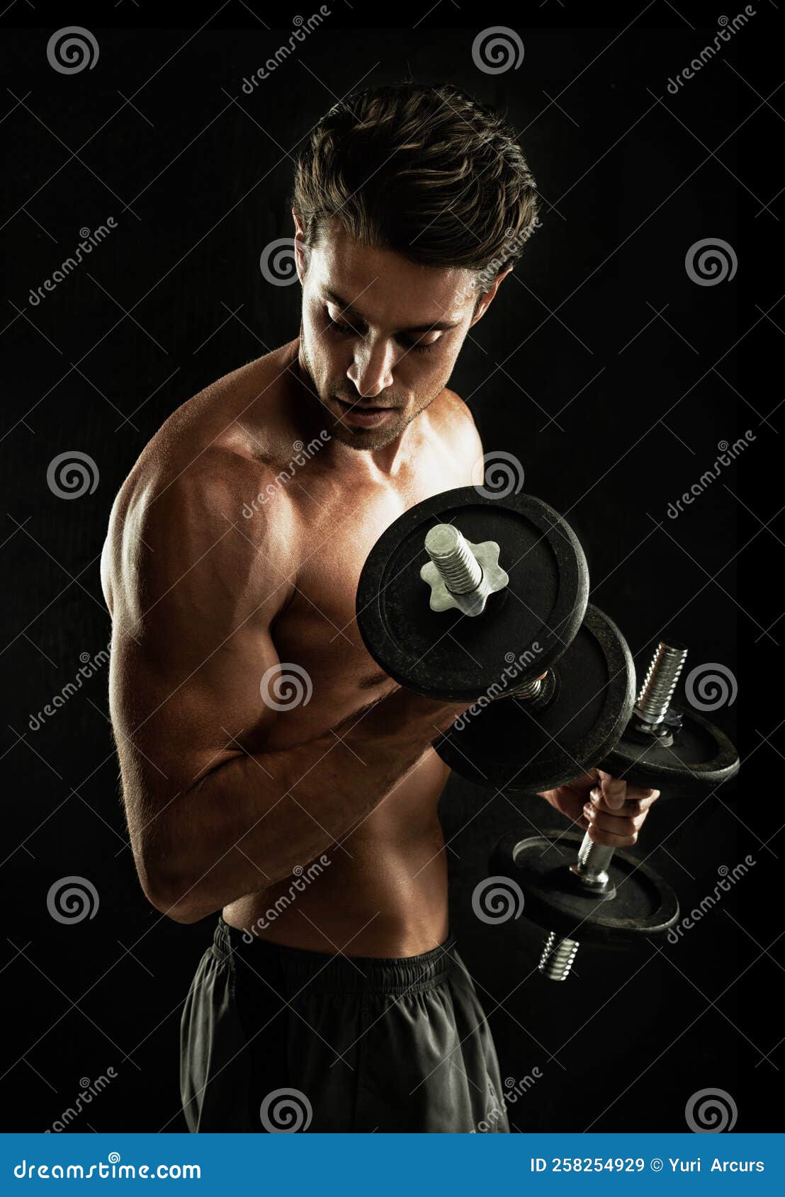 Targeting His Biceps. Young Man Isolated on Black Performing Bicep ...
