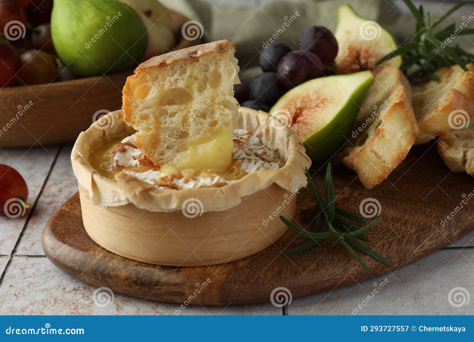 Tasty Baked Brie Cheese, Bread and Other Products on Light Tiled Table ...