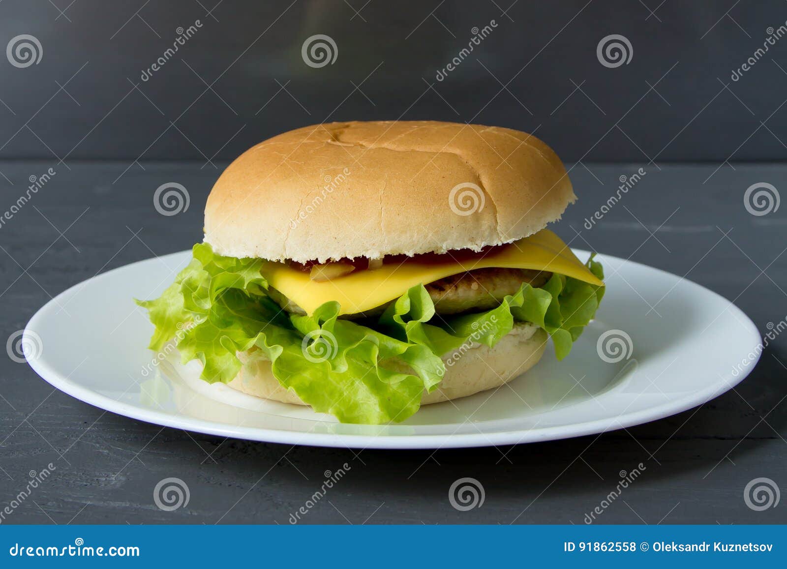 Tasty Cheeseburger on White Plate on Gray Surface Stock Photo - Image ...